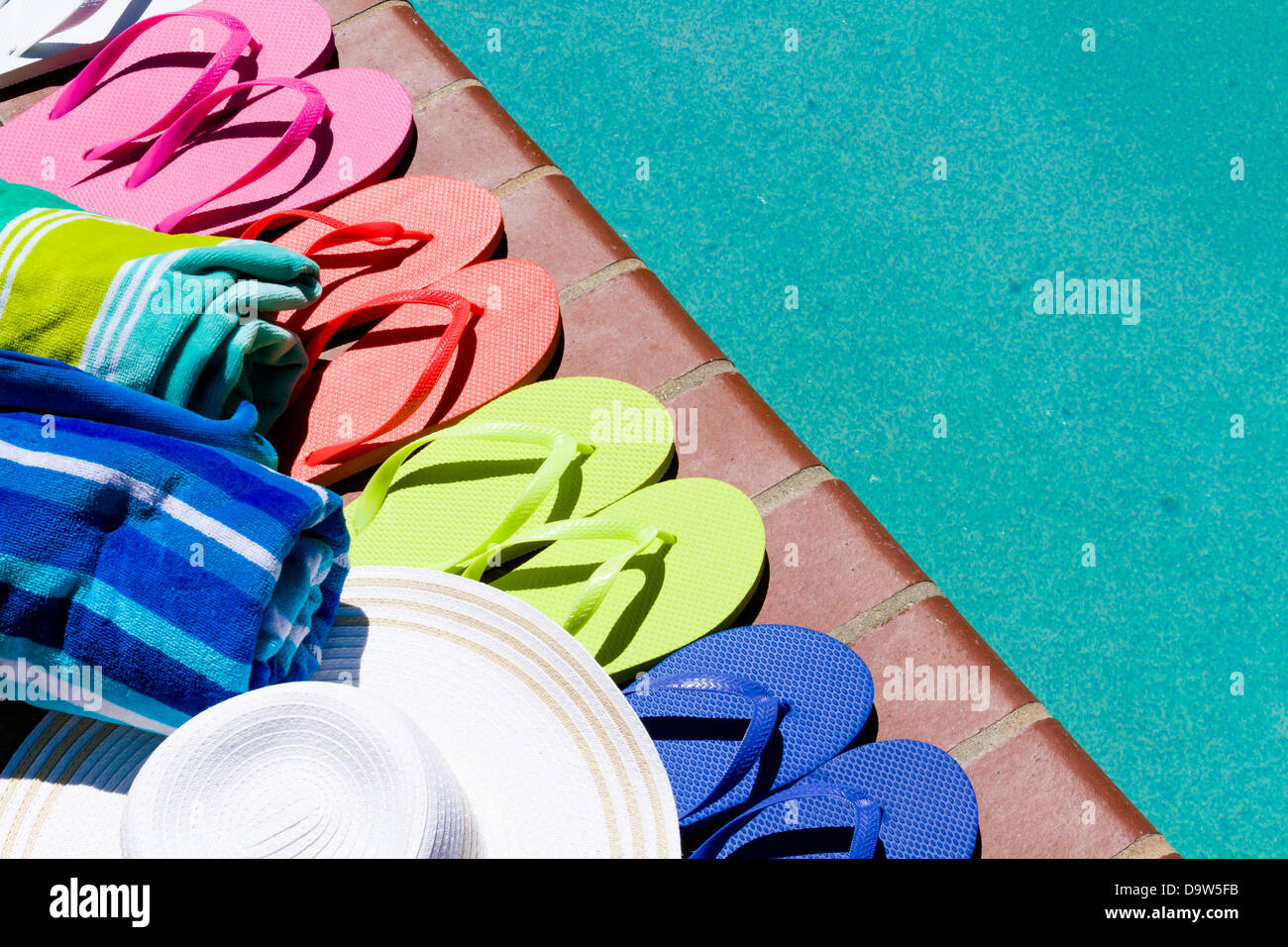 Colorful flip flops by a swimming pool Stock Photo - Alamy