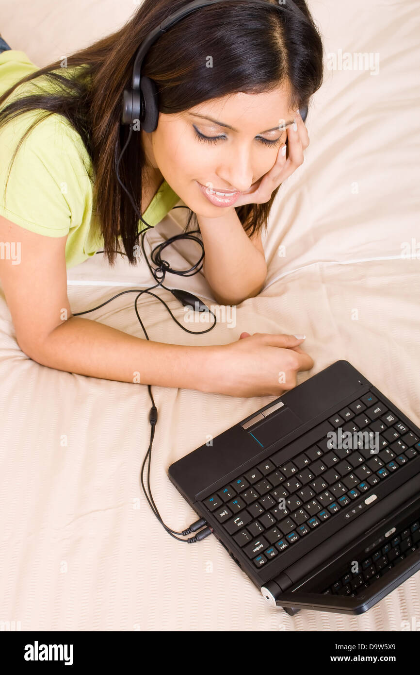 young woman listening music with a laptop Stock Photo - Alamy