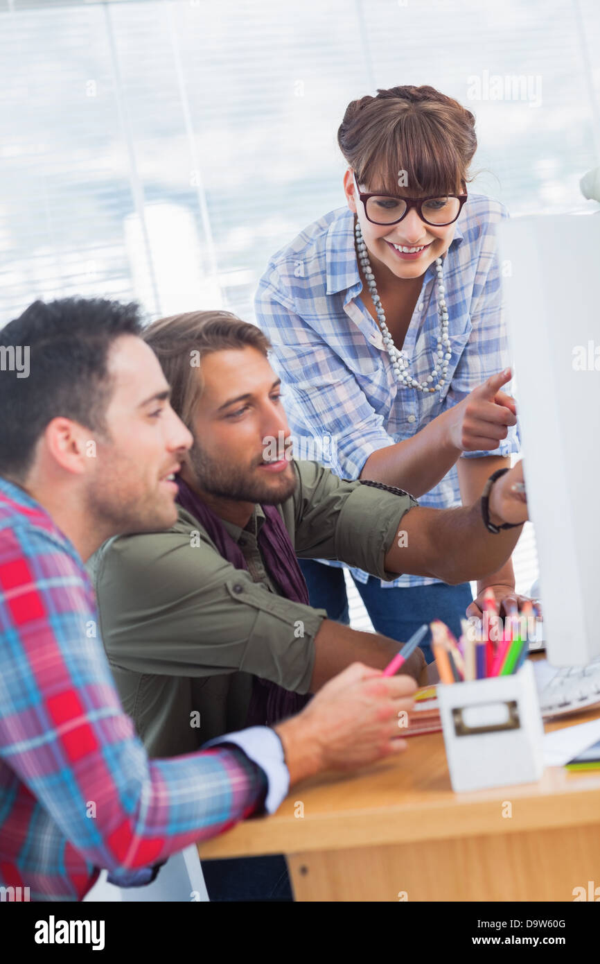 Group of designers working on a computer Stock Photo - Alamy