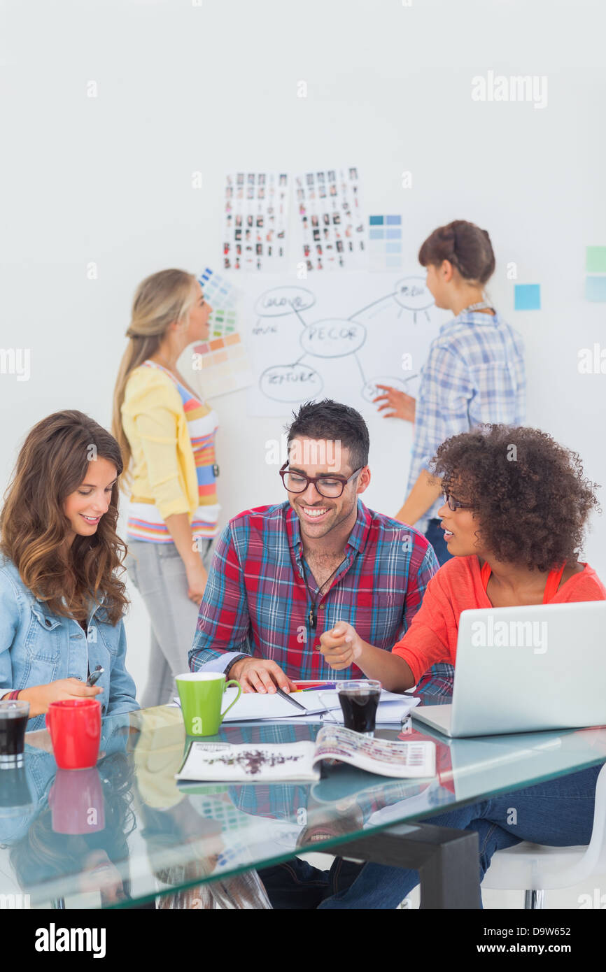 Happy designers brainstorming together Stock Photo - Alamy