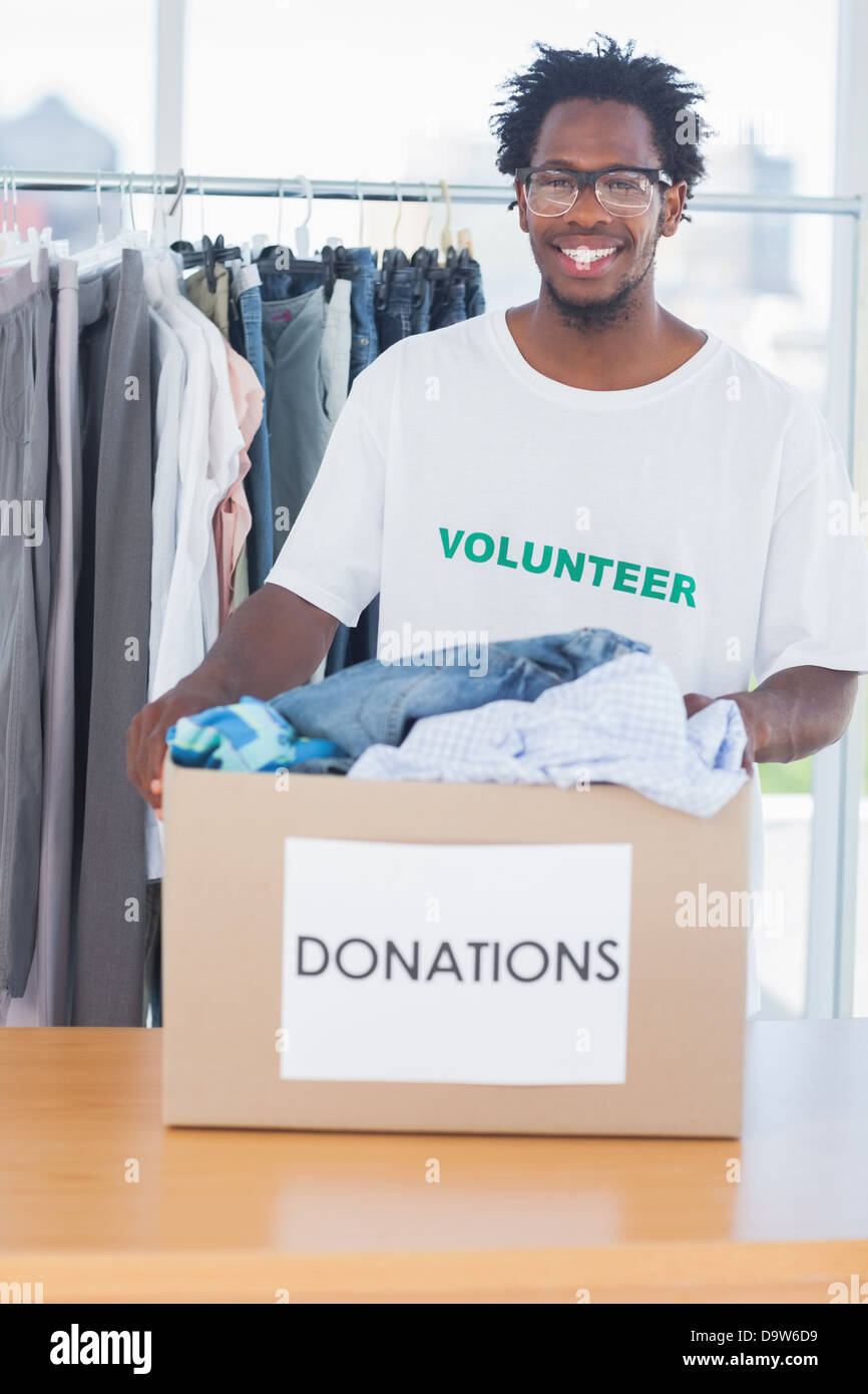Handsome man holding a donation box Stock Photo - Alamy