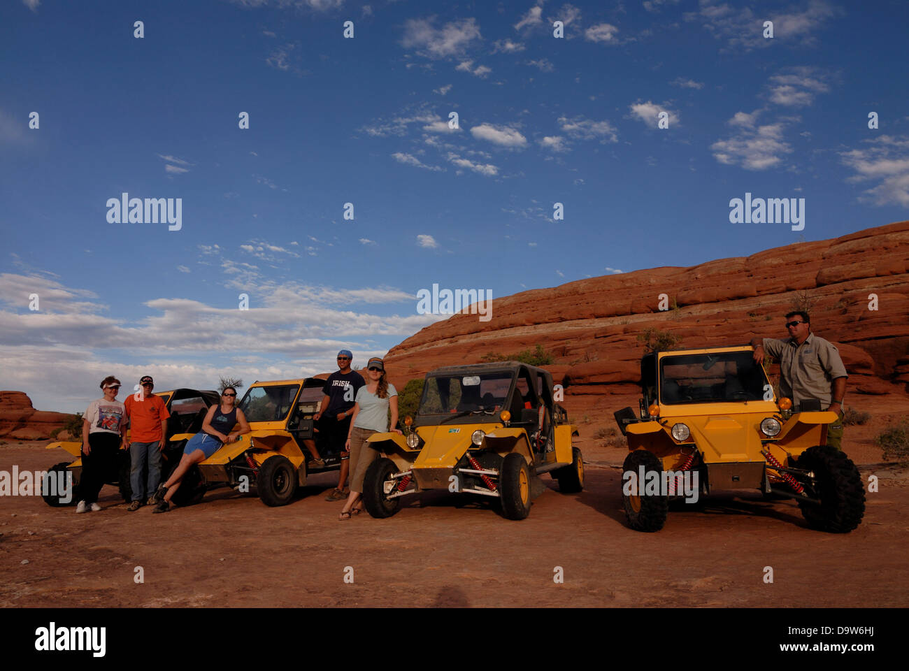Tourists posing on tomcars little Israeli buggy jeeps at Arches ...