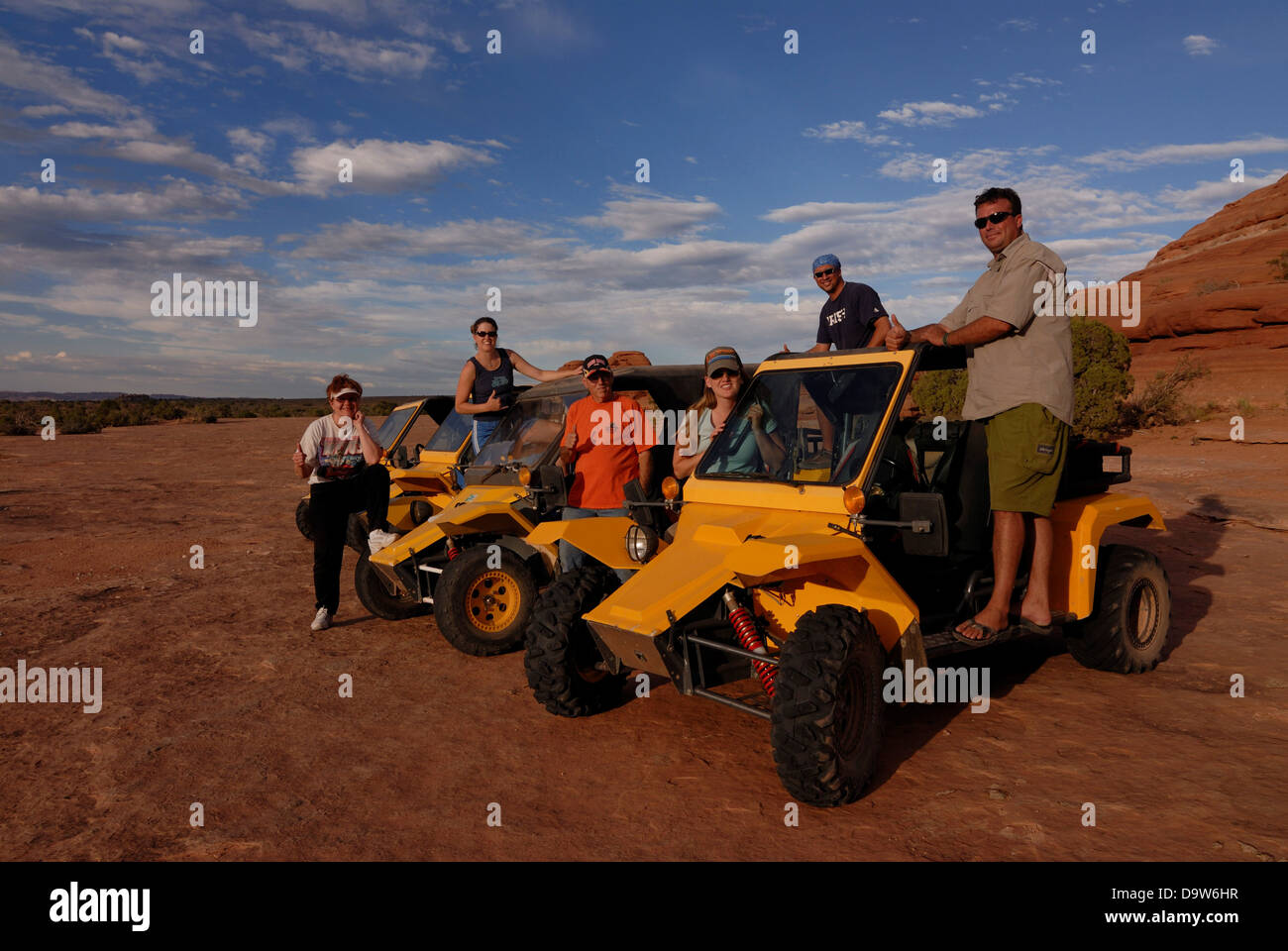 Tourists posing on tomcars little Israeli buggy jeeps at Arches ...