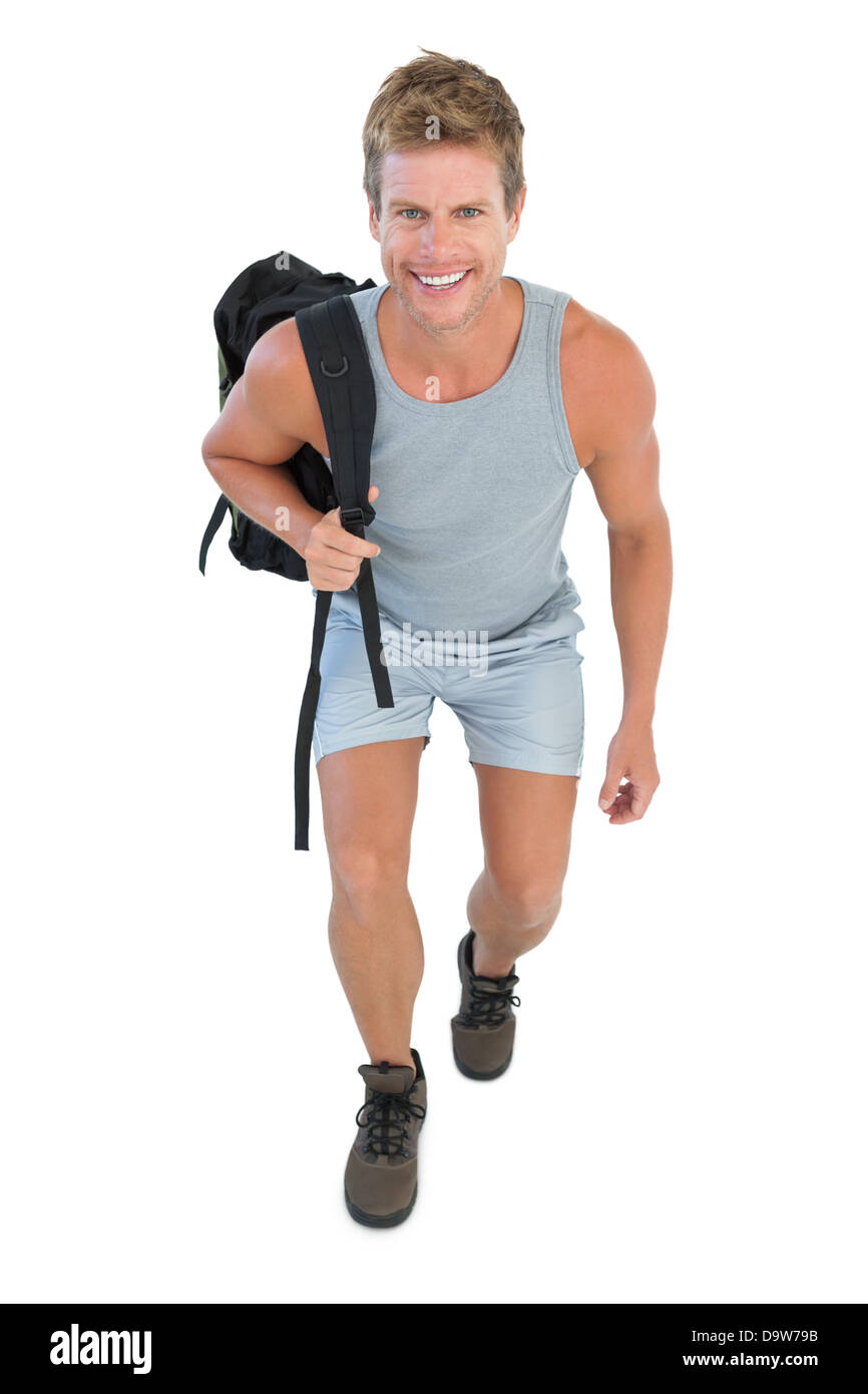 Cheerful man holding backpack Stock Photo - Alamy