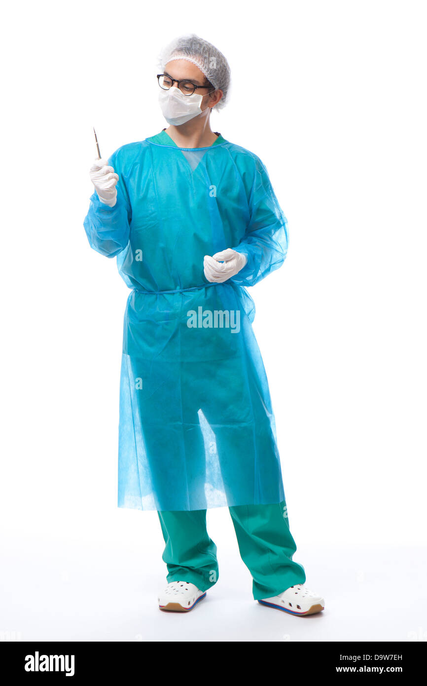 Male surgeon holding scalpel in theater scrubs Stock Photo - Alamy