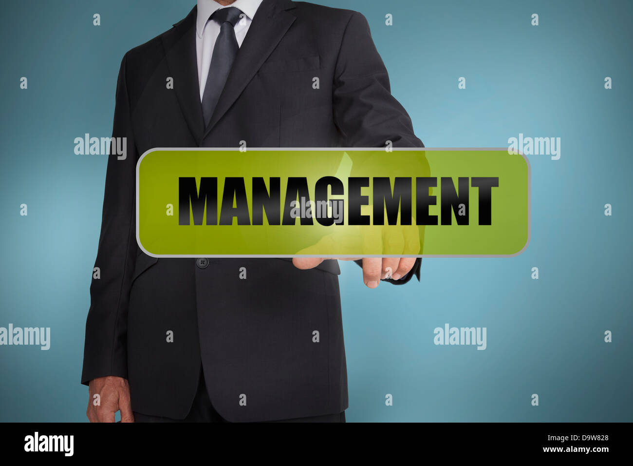 Businessman touching the word management written on green tag Stock ...