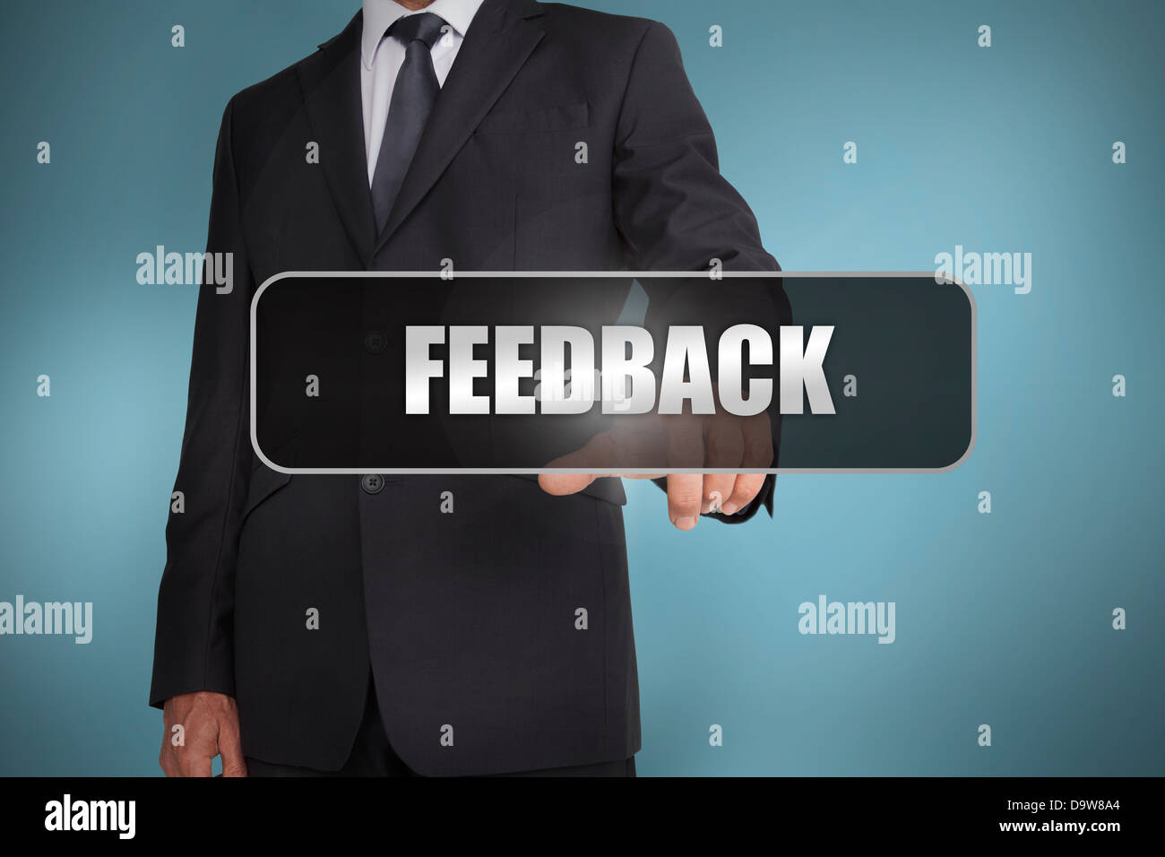 Businessman touching the word feedback written on black tag Stock Photo ...