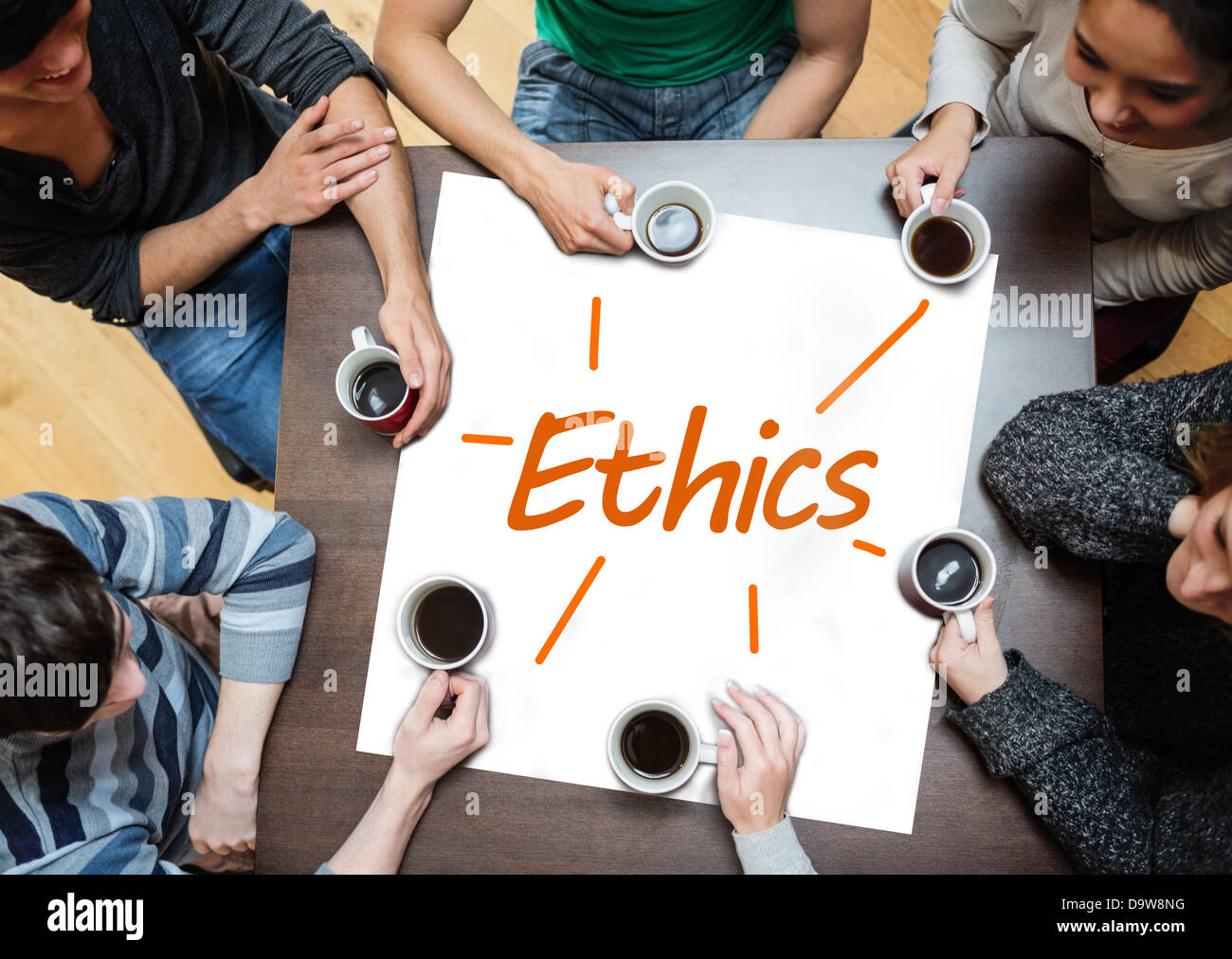 Team brainstorming over a poster with ethics written on it Stock Photo ...