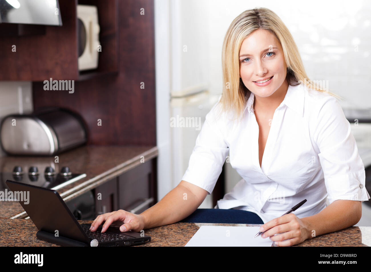 beautiful young blonde woman working from home Stock Photo - Alamy