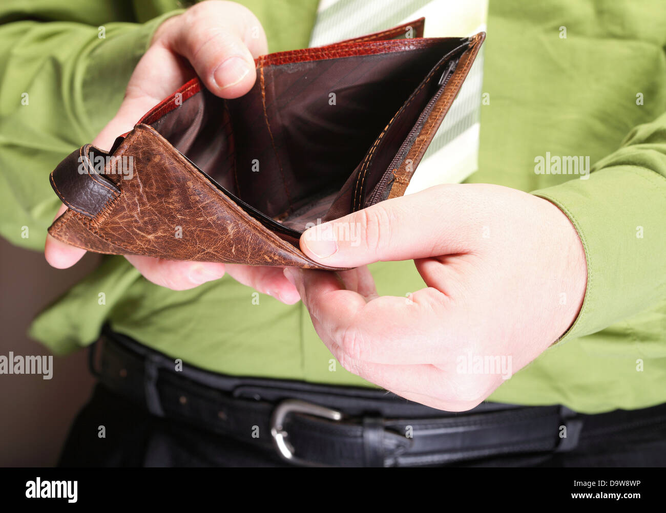 Poor economy represented by empty wallet in businessman's hands Stock ...