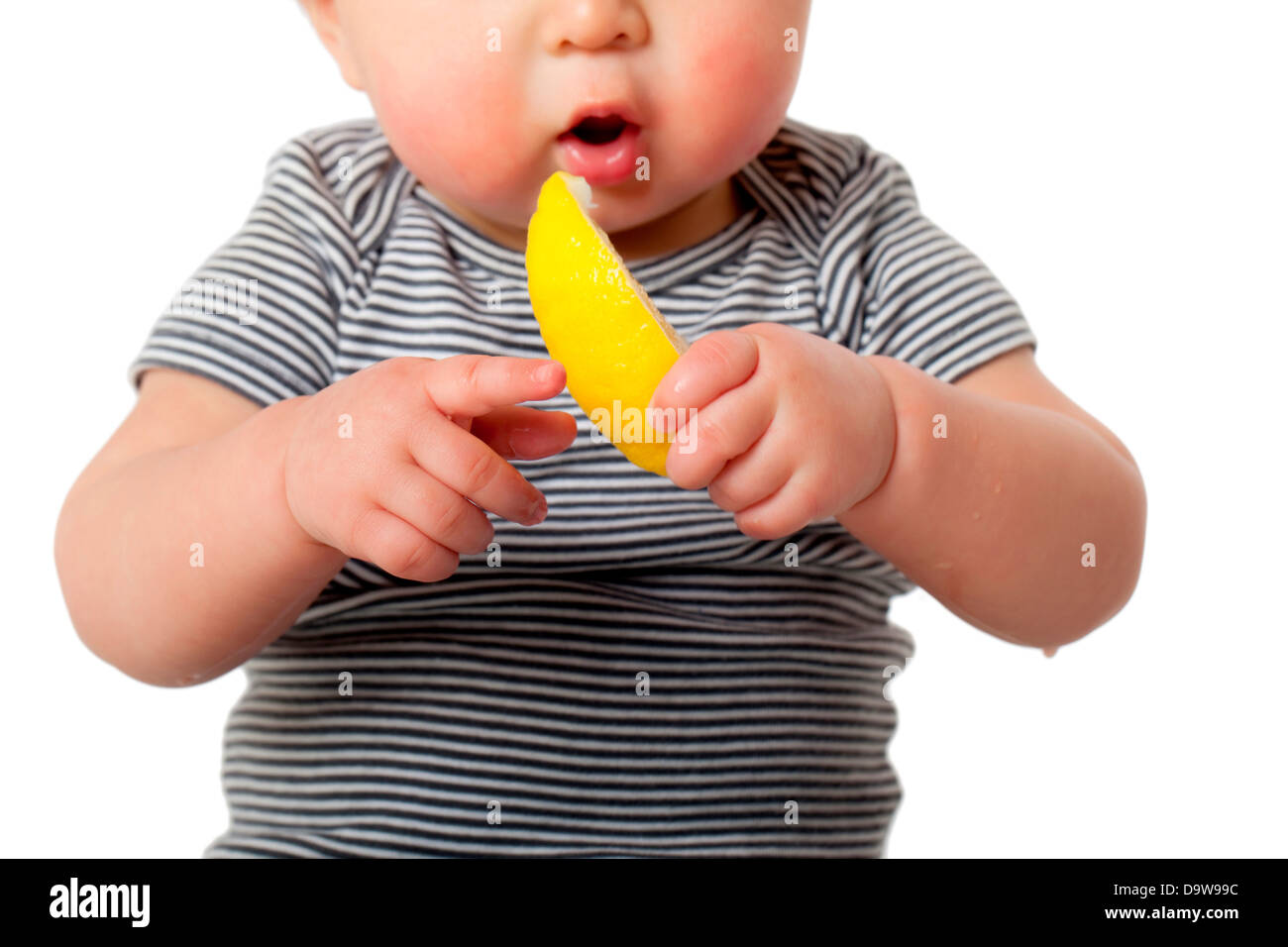 Mid section of toddler (12-17 months) touching tropical fruit Stock ...