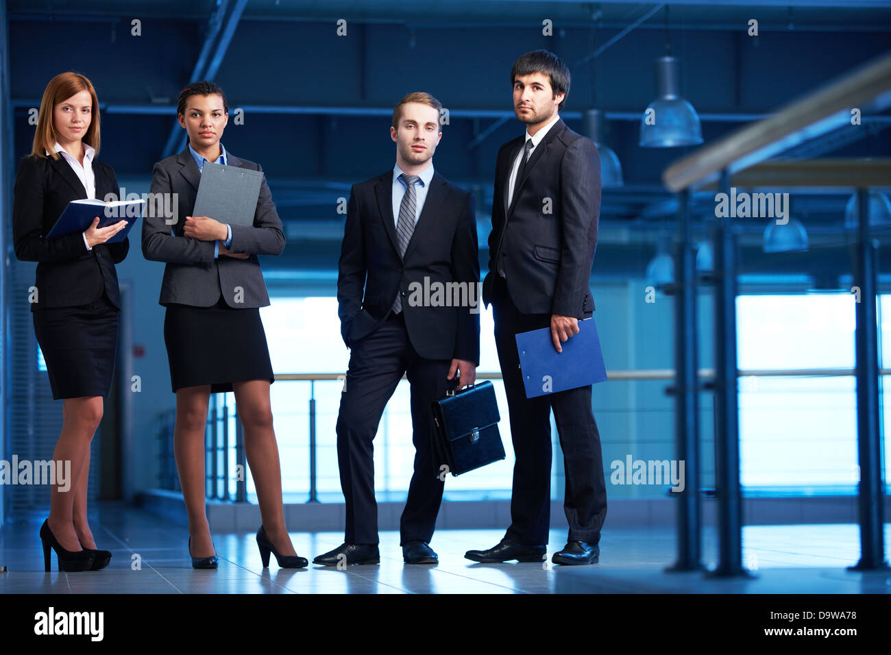 Group of friendly businesspeople in suits standing in line Stock Photo ...