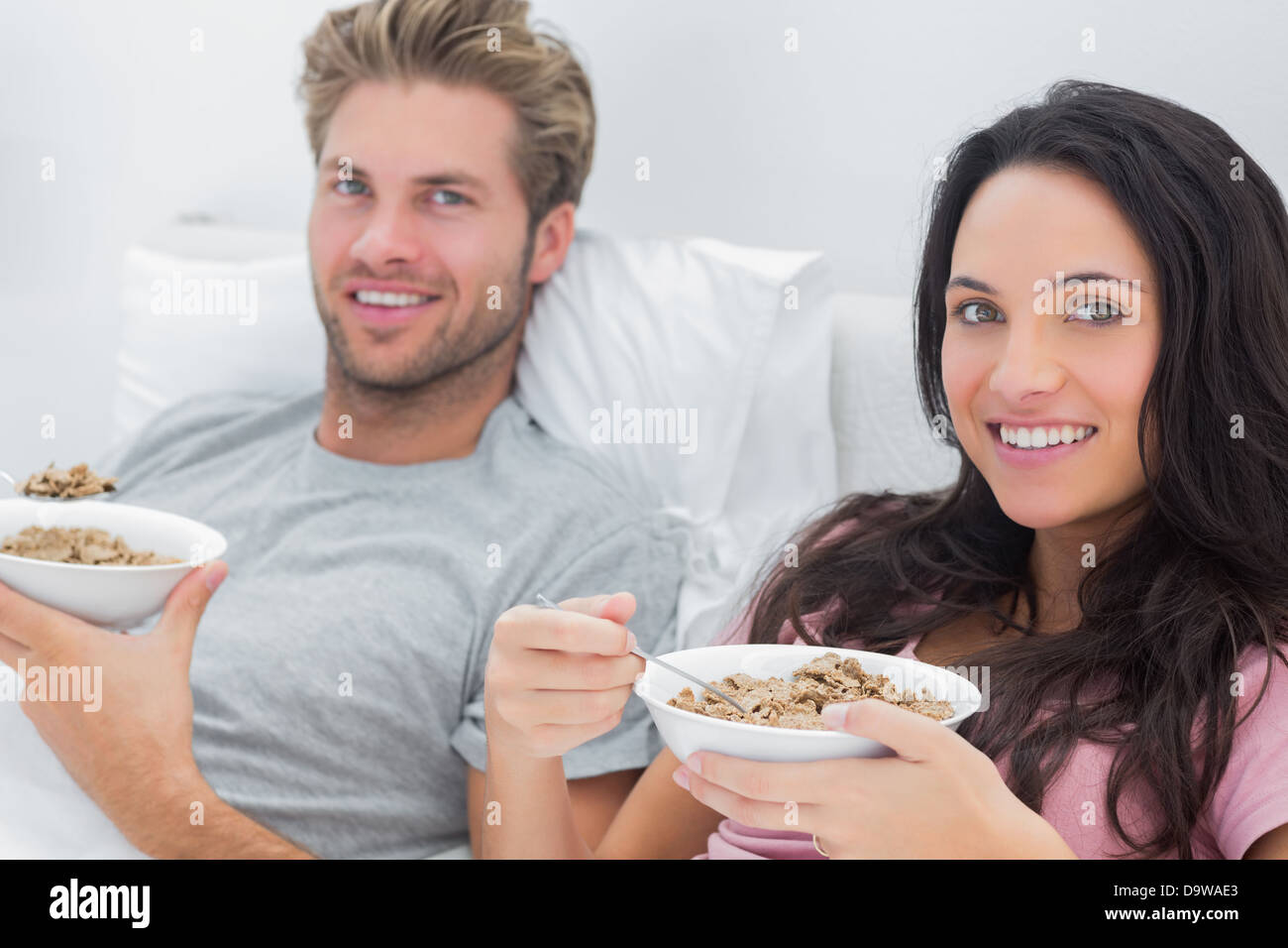 Couple eating cereal for breakfast Stock Photo - Alamy