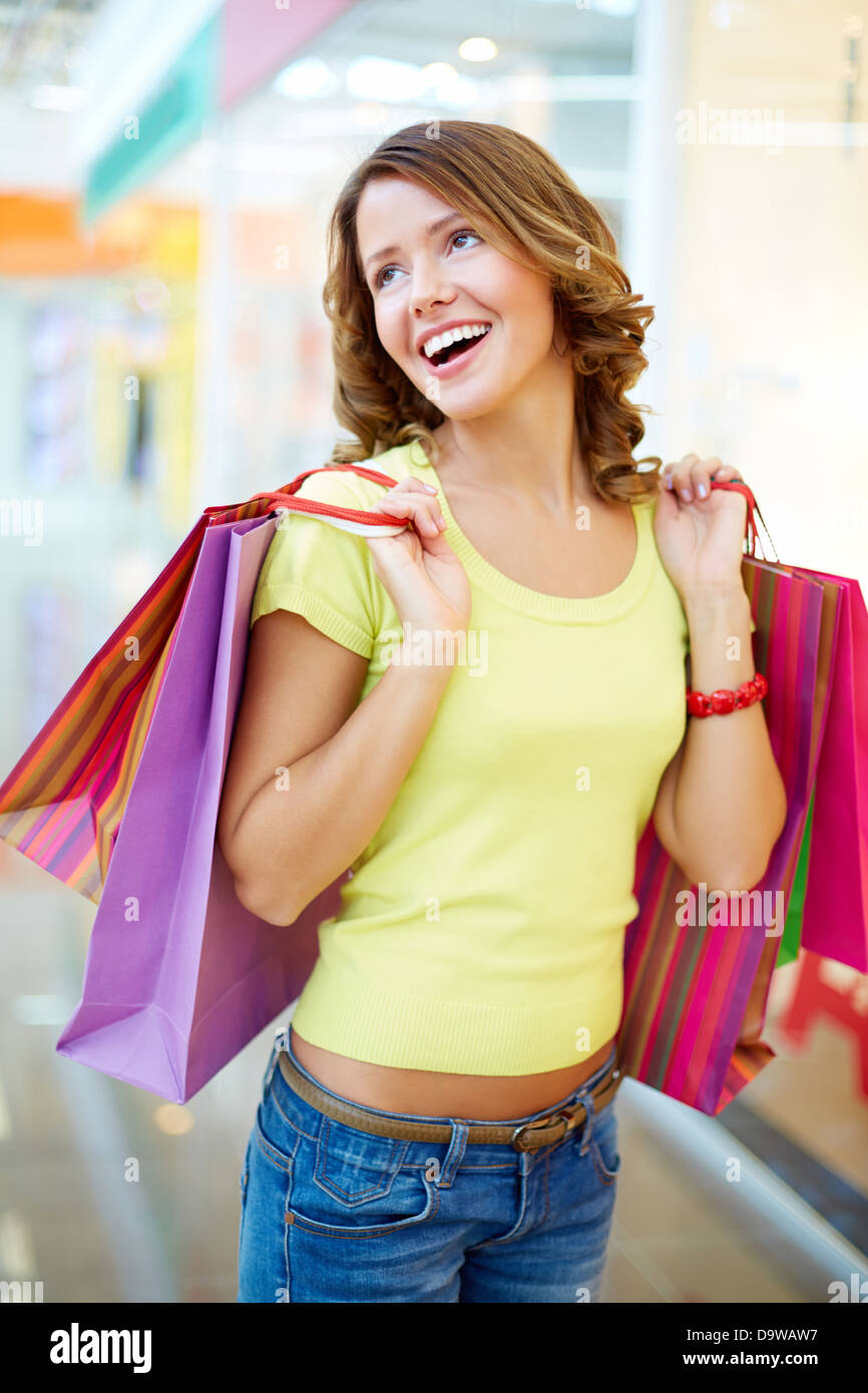 Young shopper being happy with her purchases and herself Stock Photo ...