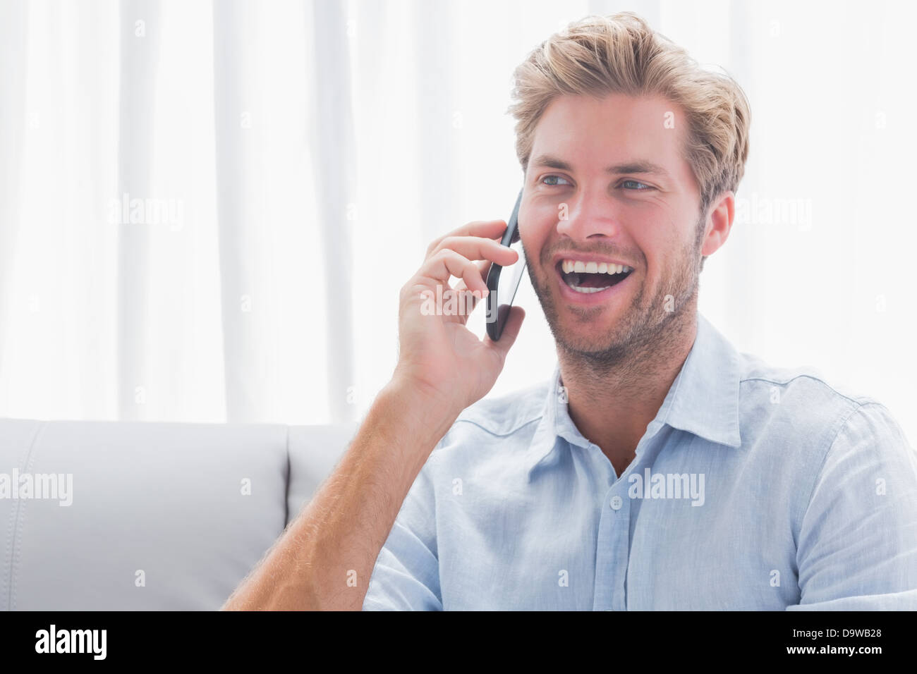 Man laughing while he is on the phone Stock Photo - Alamy