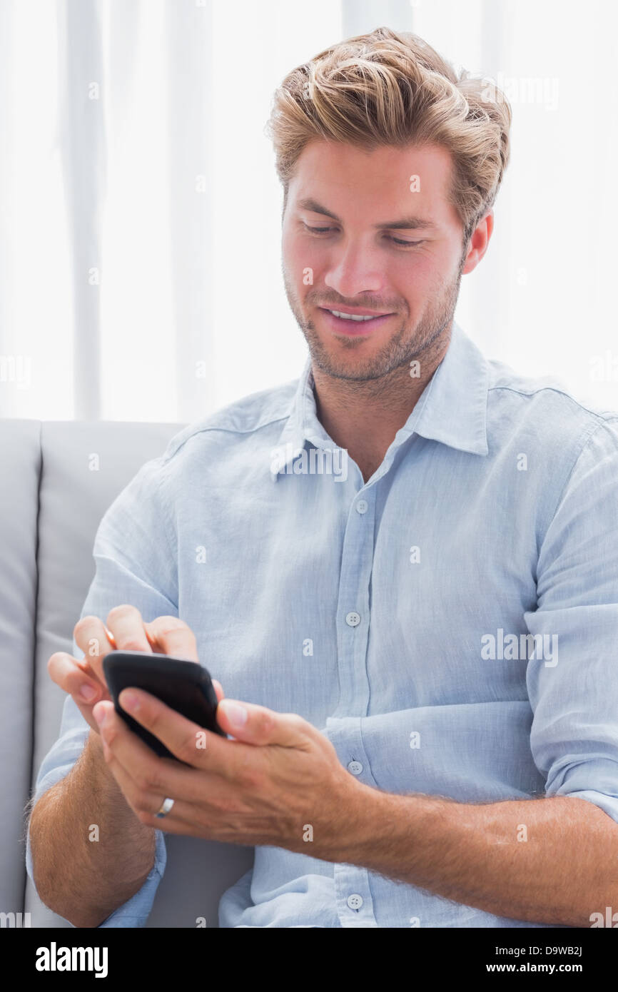 Man using his smartphone on a couch Stock Photo - Alamy Man using his smartphone on a couch Stock Photo - Alamy