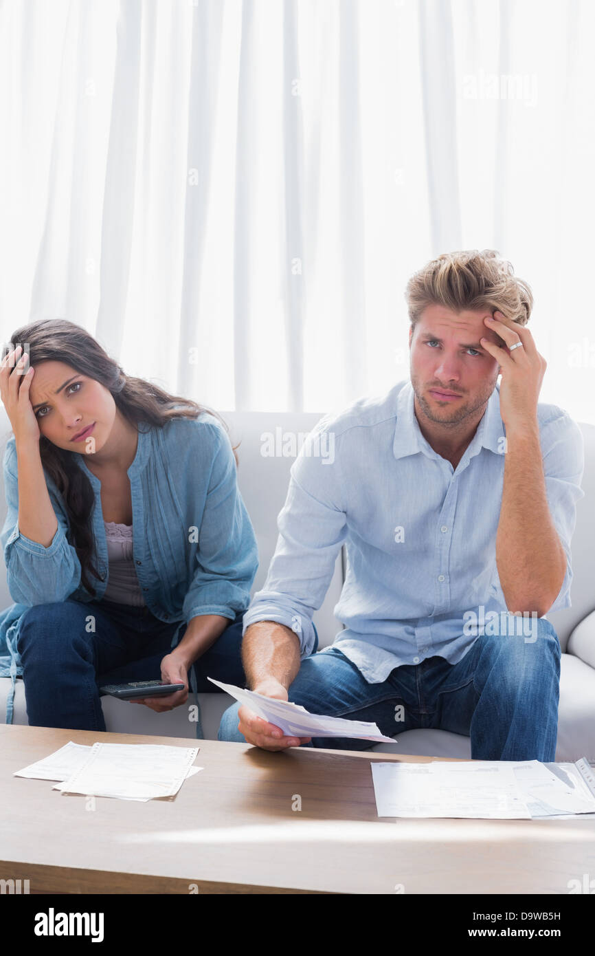 Anxious couple doing their accounts Stock Photo - Alamy