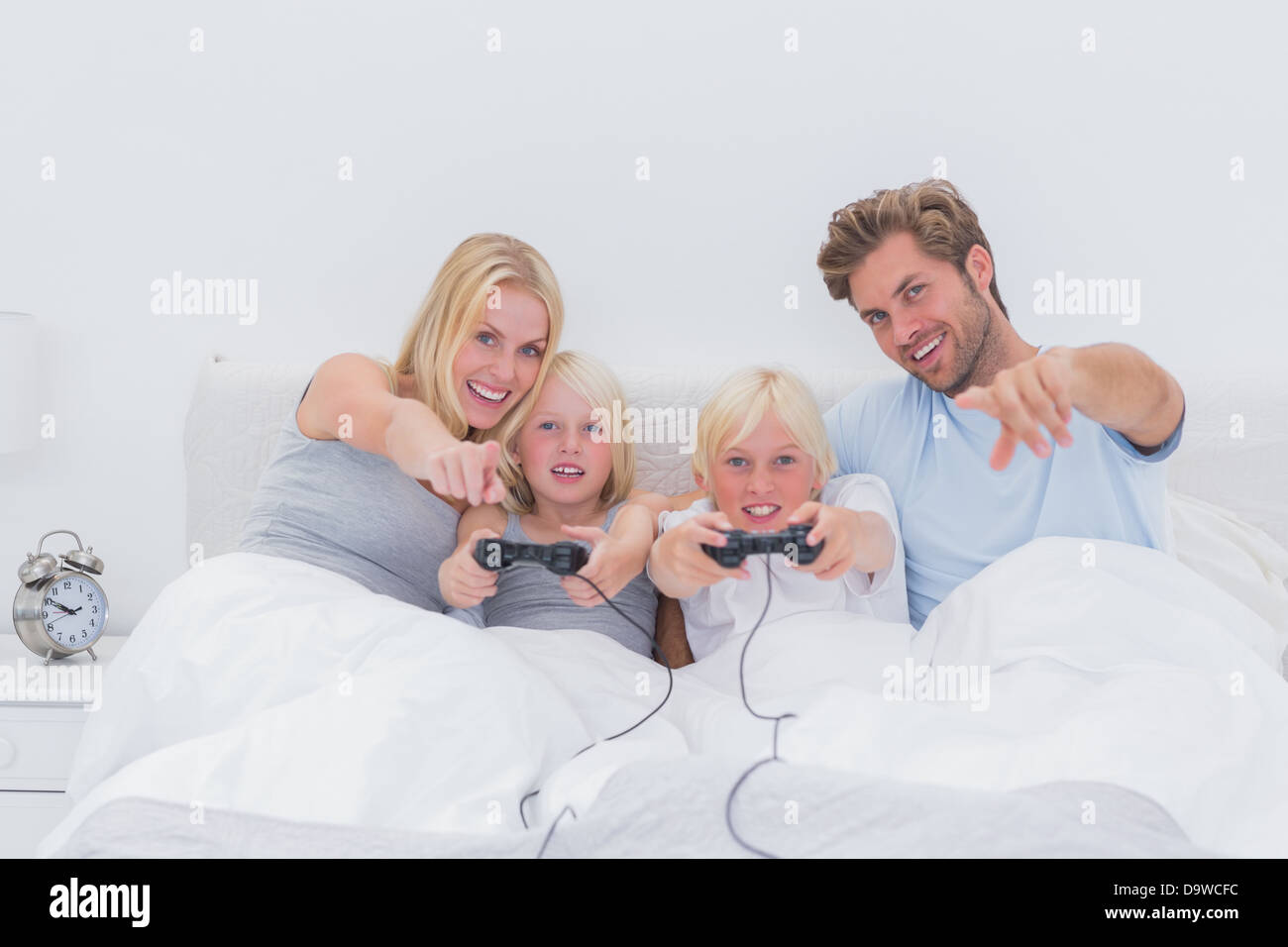 Competitive family playing video games hi-res stock photography and ...