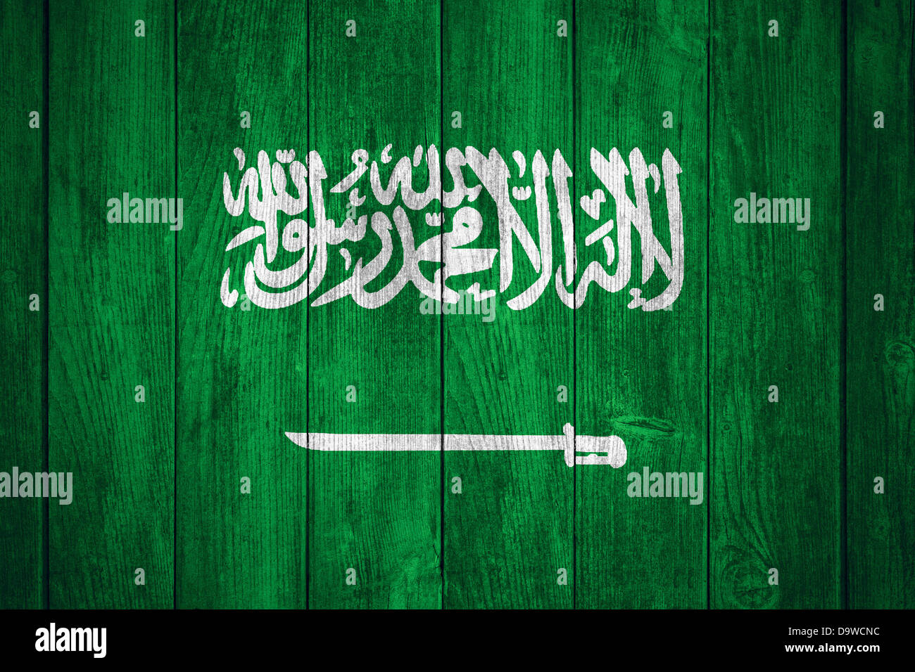 flag of Saudi Arabia or green and white banner on wooden background ...