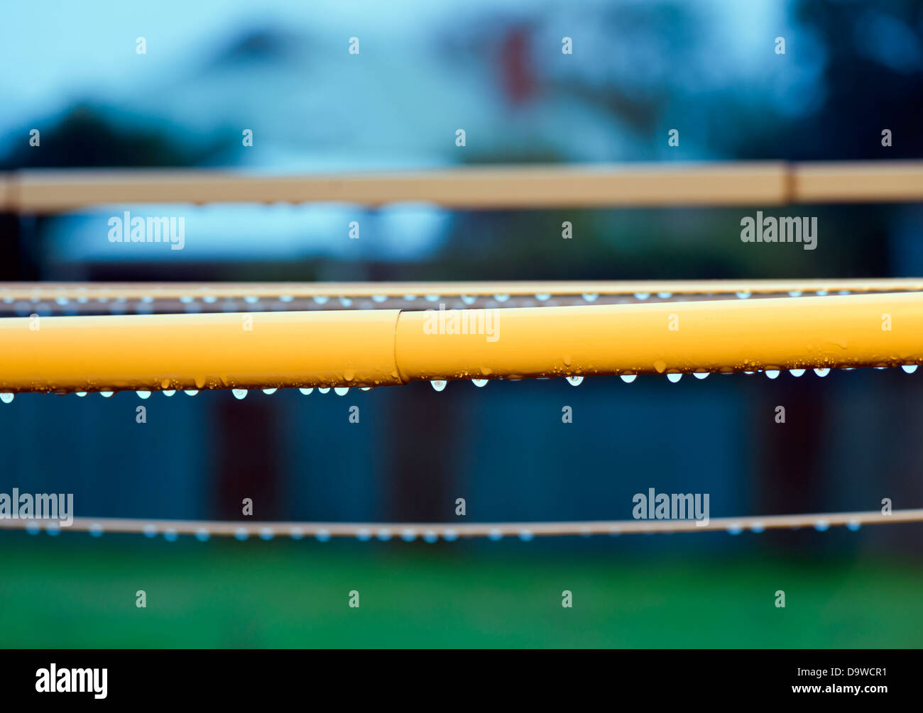 Rain drops cling to the underside of a clothes line Stock Photo - Alamy
