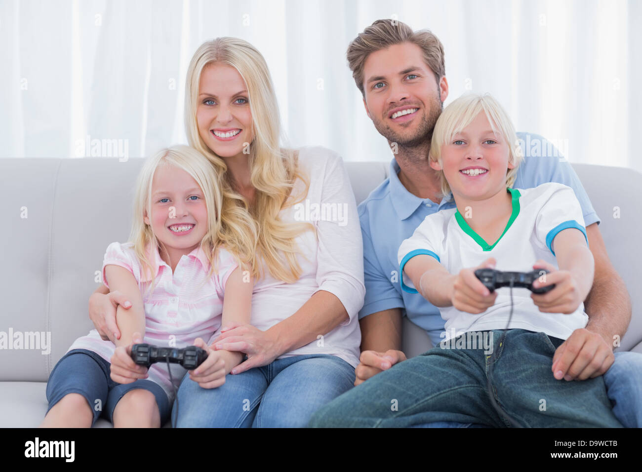 Competitive family playing video games hi-res stock photography and ...