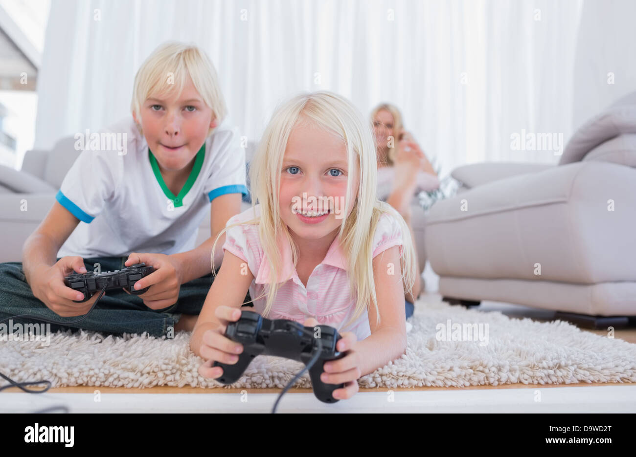 Siblings playing video games Stock Photo - Alamy