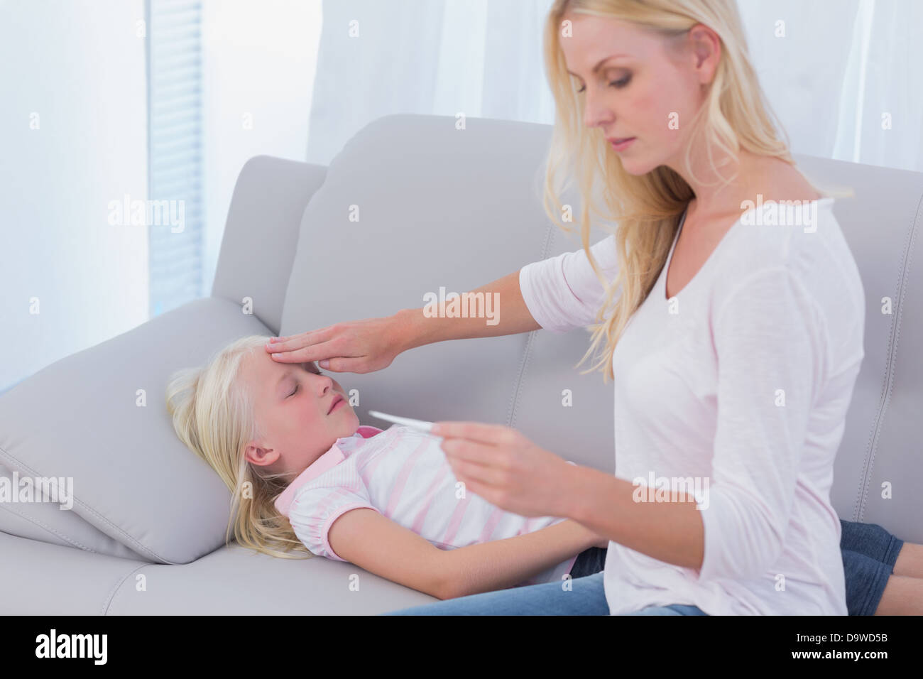 Mother taking care of her sick daughter Stock Photo - Alamy