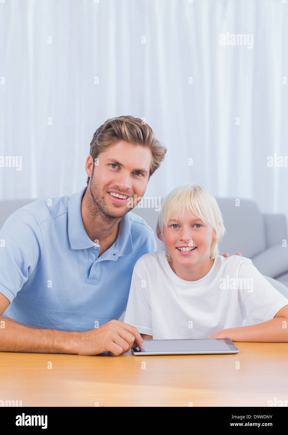 Father using tablet with his son Stock Photo - Alamy