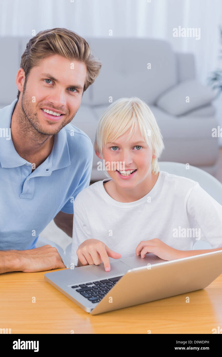 Father using laptop with his son Stock Photo - Alamy