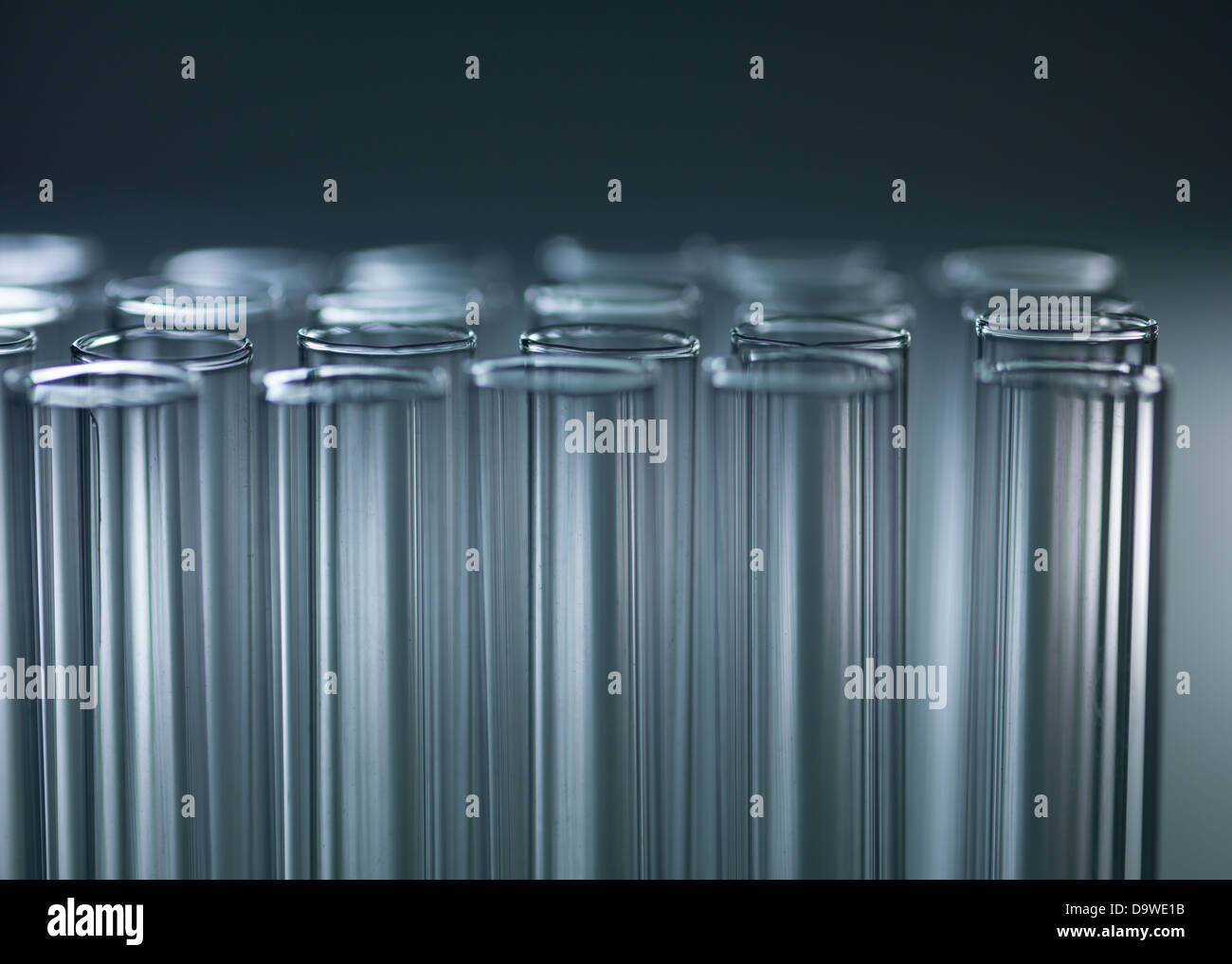 A close-up of three rows of vertical tubes on a dark grey gradient ...