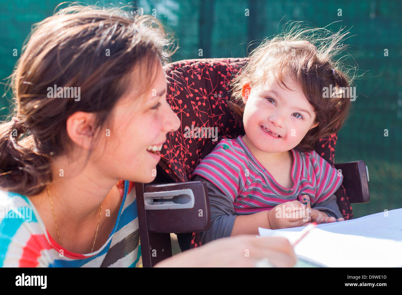 2 and a half year old girl with Down's syndrome with her mother Stock ...