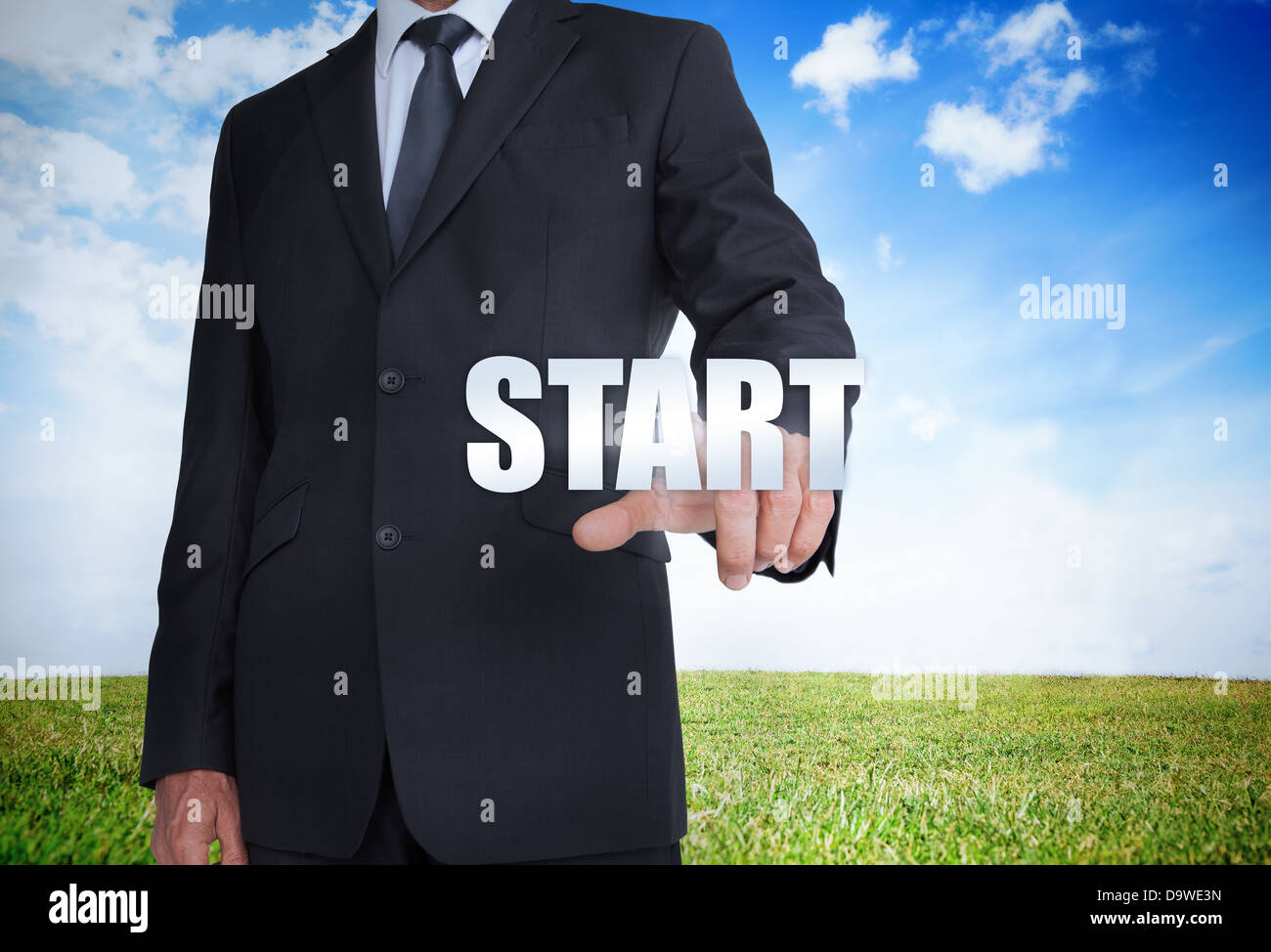 Businessman selecting start word Stock Photo - Alamy