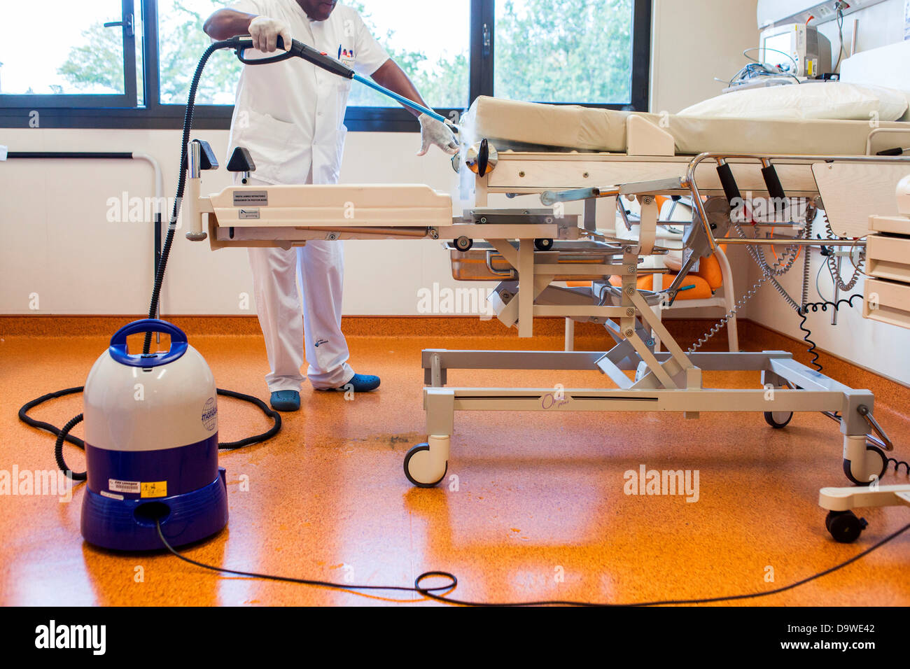 Hospital staff disinfecting the delivery room. Obstetrics and ...
