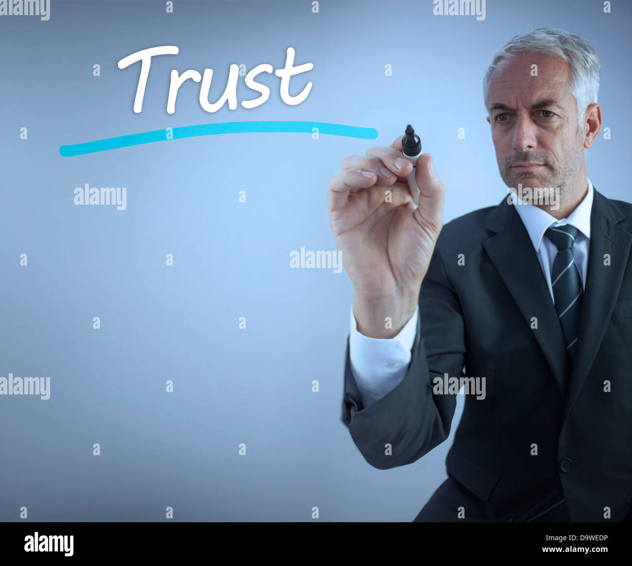 Businessman writing the word trust Stock Photo - Alamy