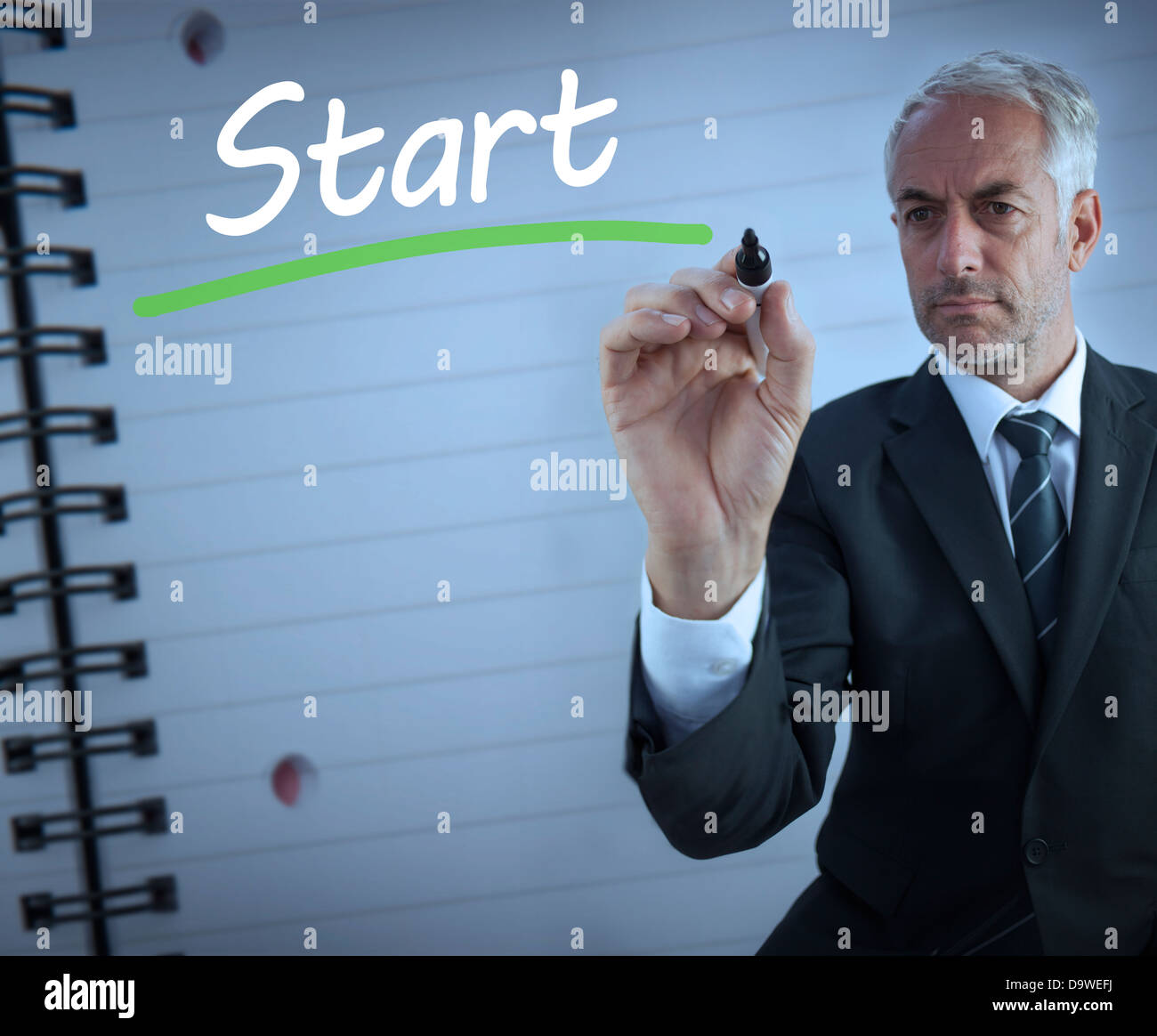 Businessman standing and writing the word start Stock Photo - Alamy