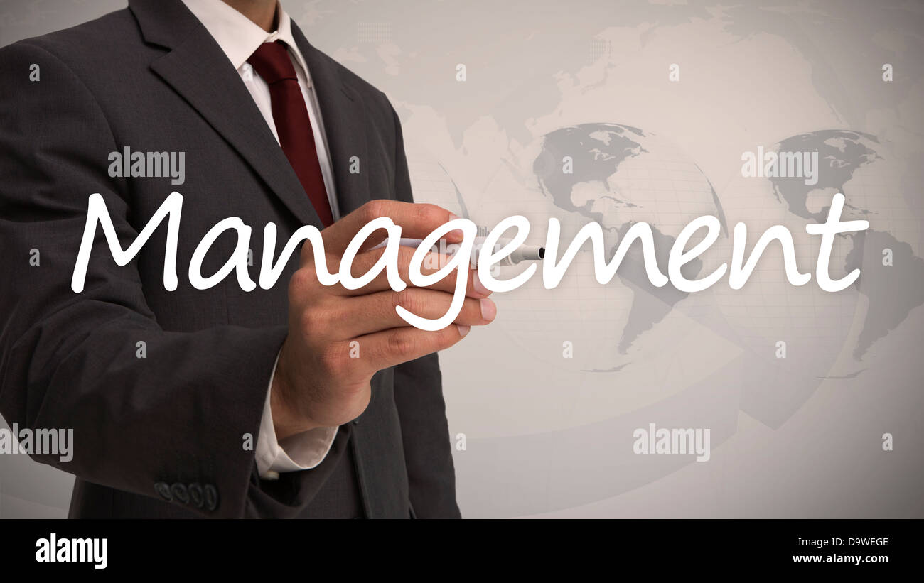 Businessman writing the word management Stock Photo - Alamy