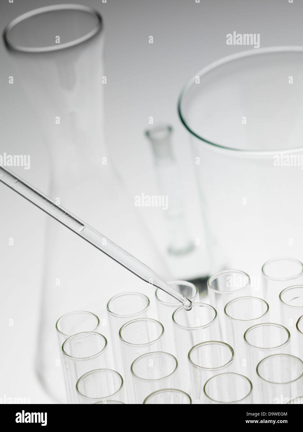 grey gradient background with laboratory glassware with pipette ...