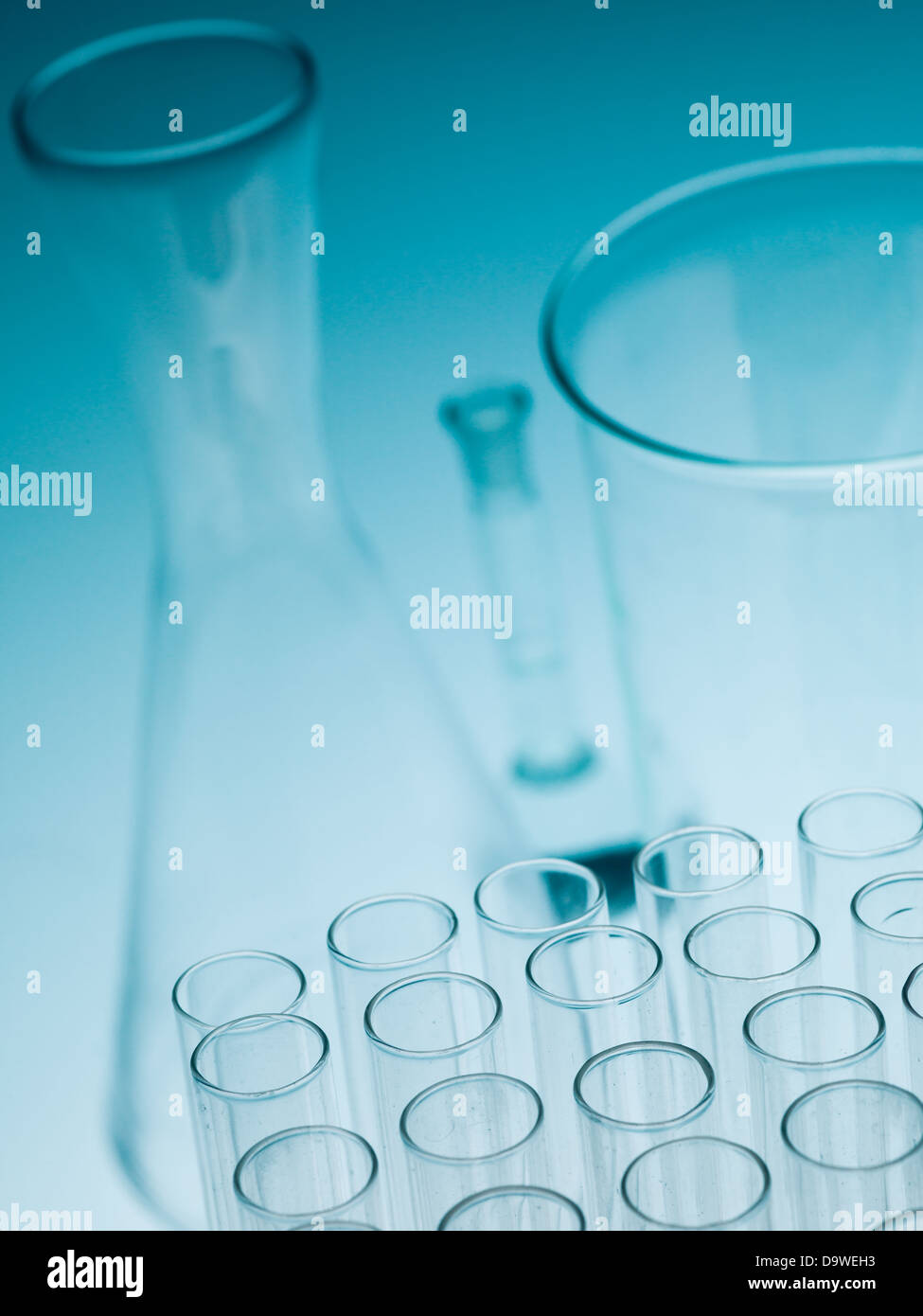 blue gradient background with empty laboratory glassware with test ...