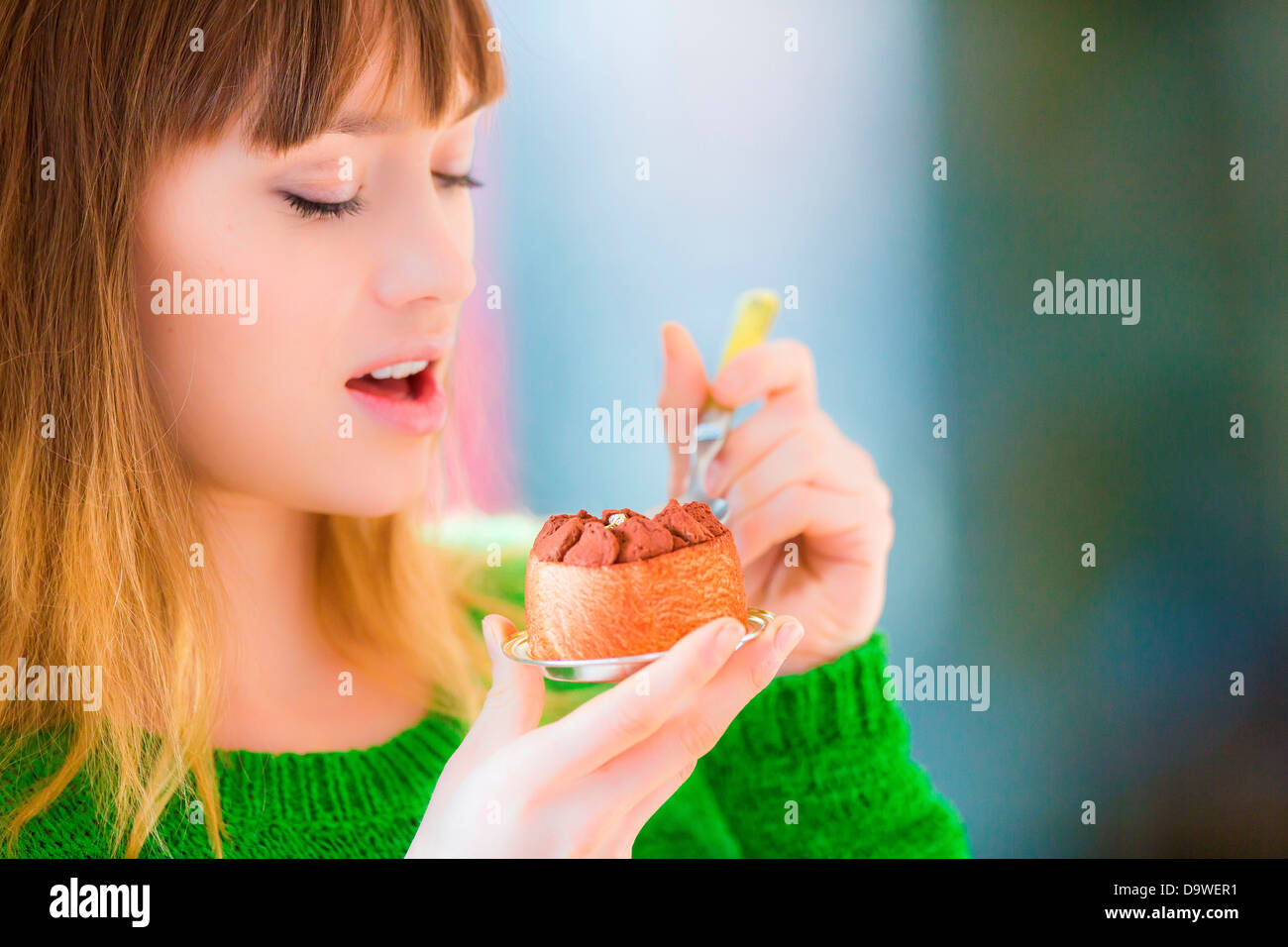 Woman eating a chocolate cake Stock Photo - Alamy