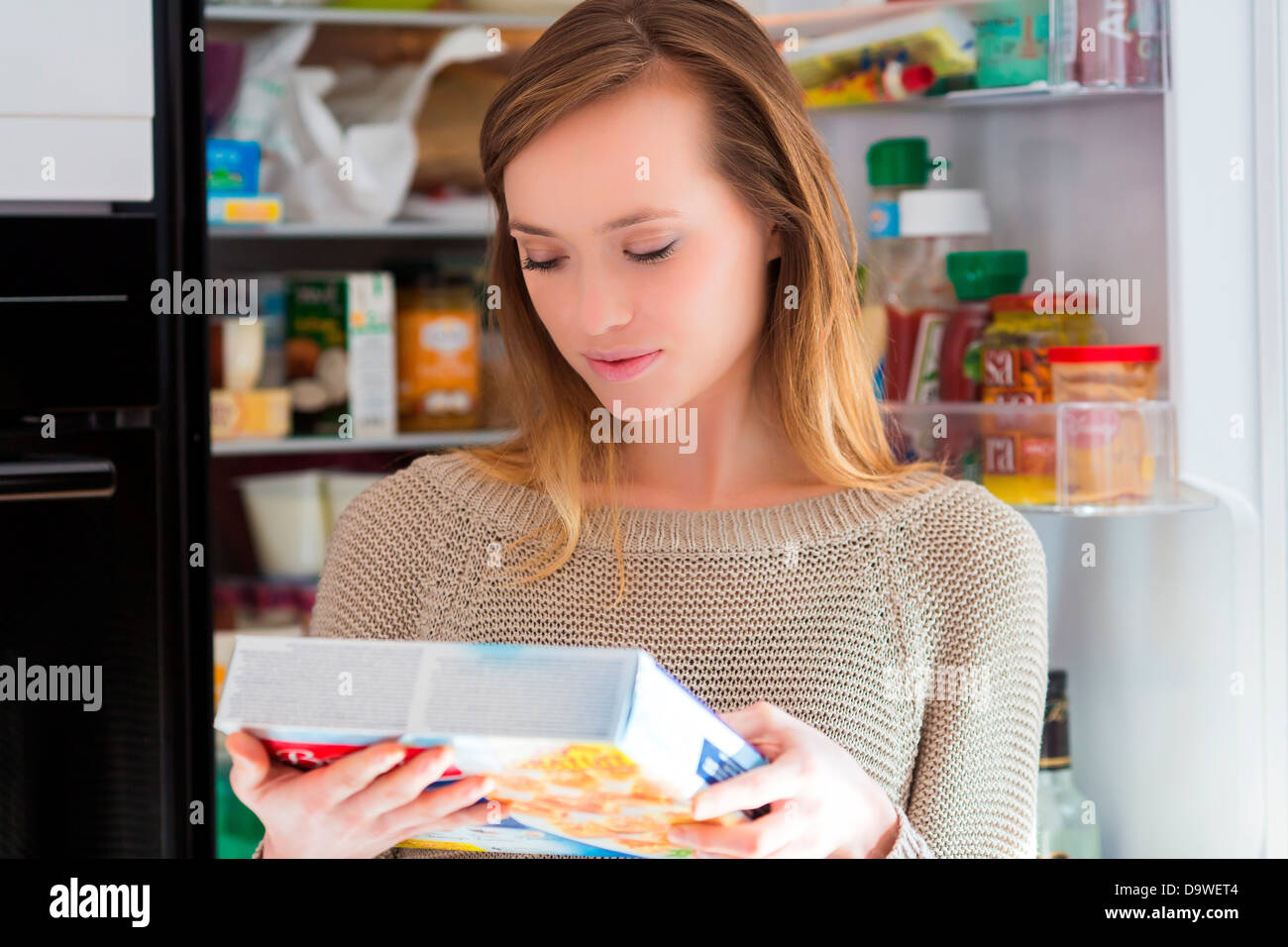 Woman checking the composition and nutrition facts Stock Photo - Alamy