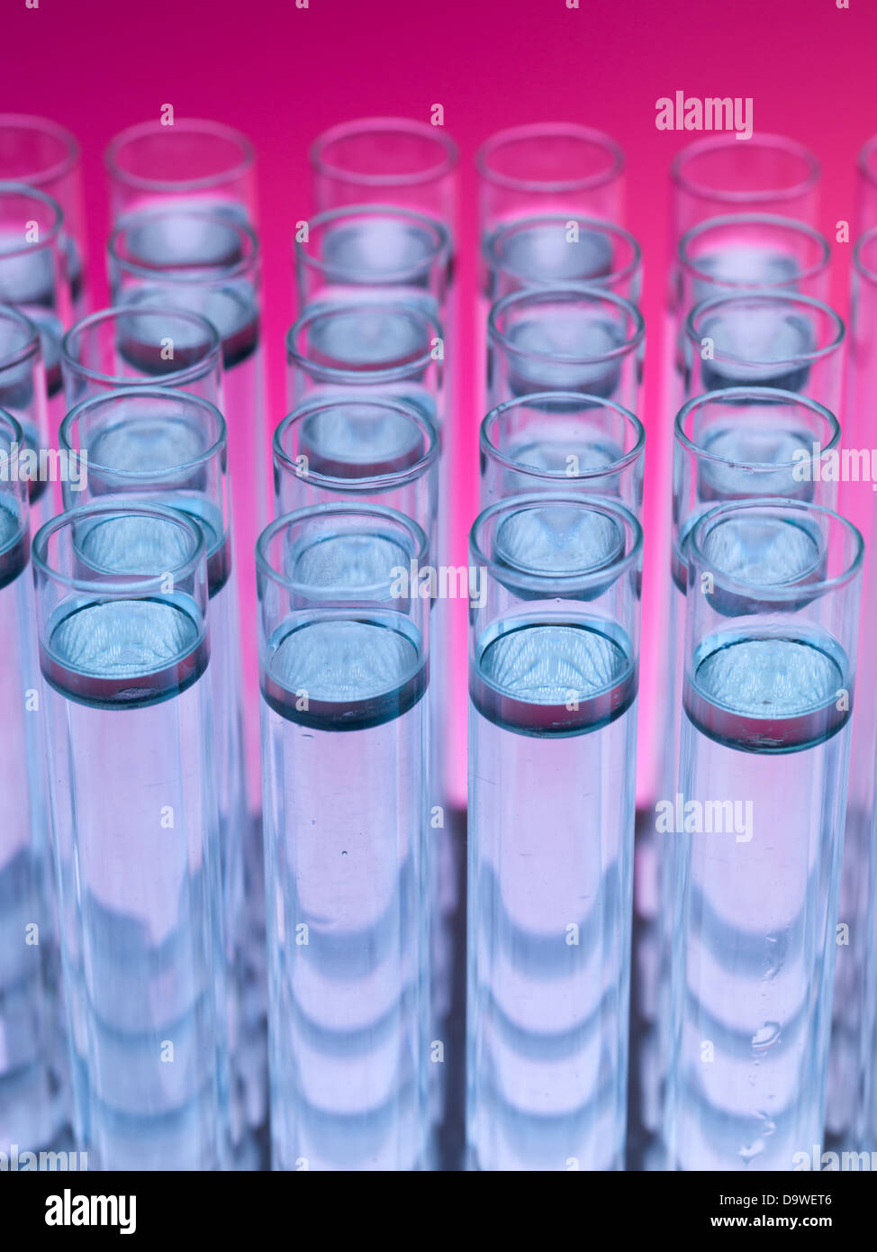 macro of test tubes filled with transparent dark floating substance in ...