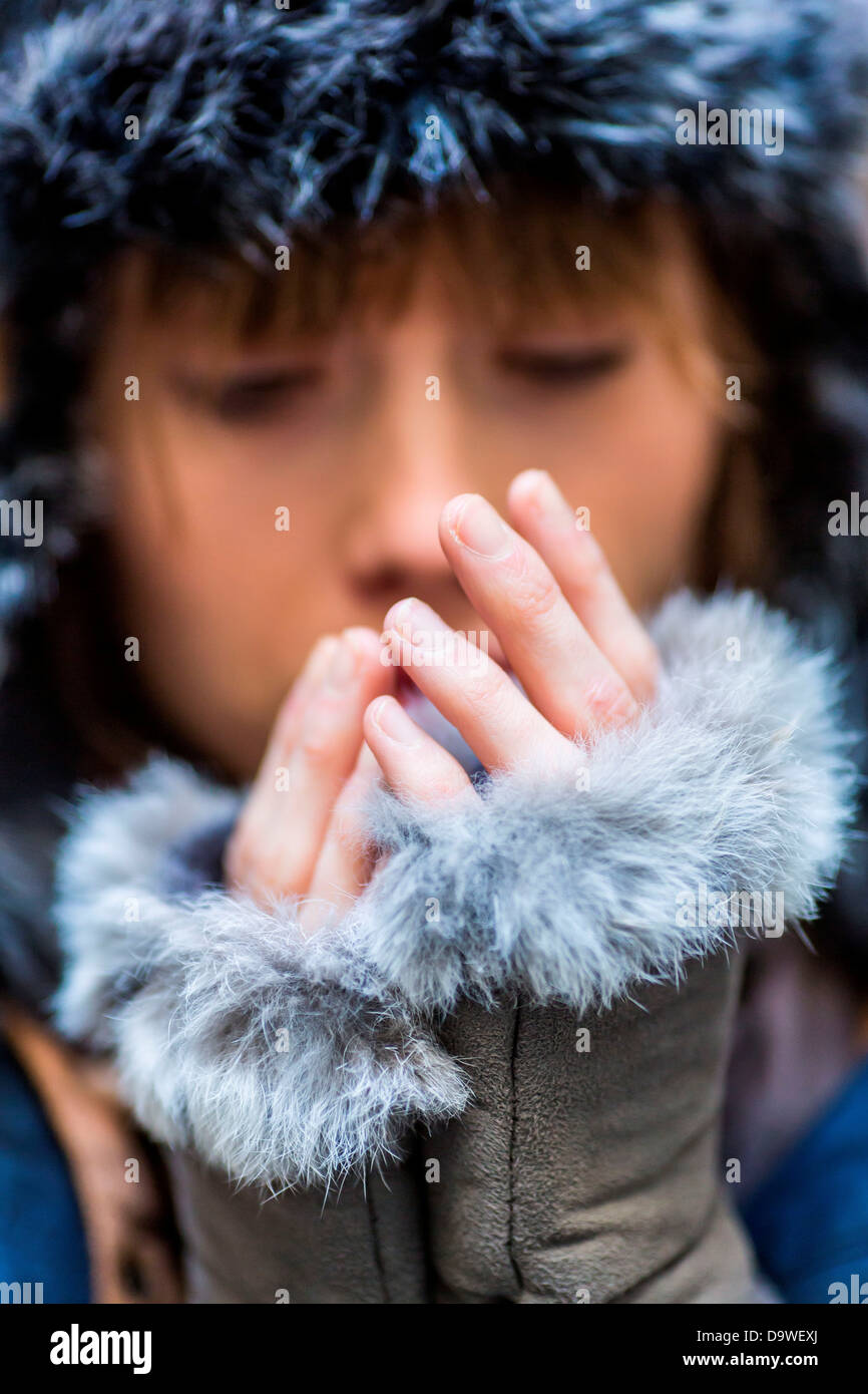 Woman blowing on his hands Stock Photo - Alamy