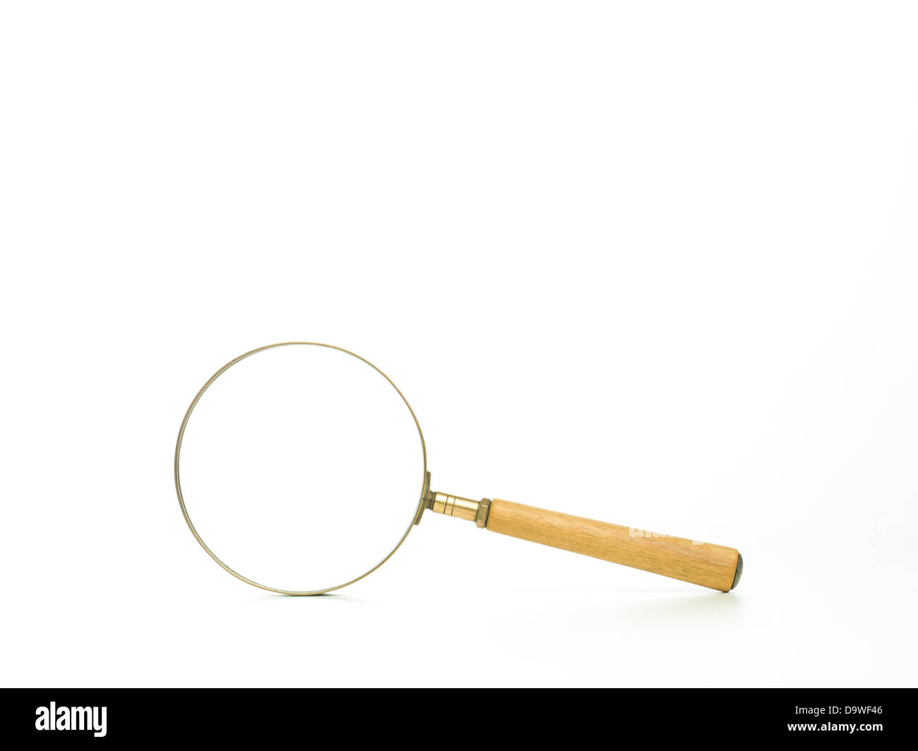 Close-up of a magnifier with a brown handle on a white backround ...