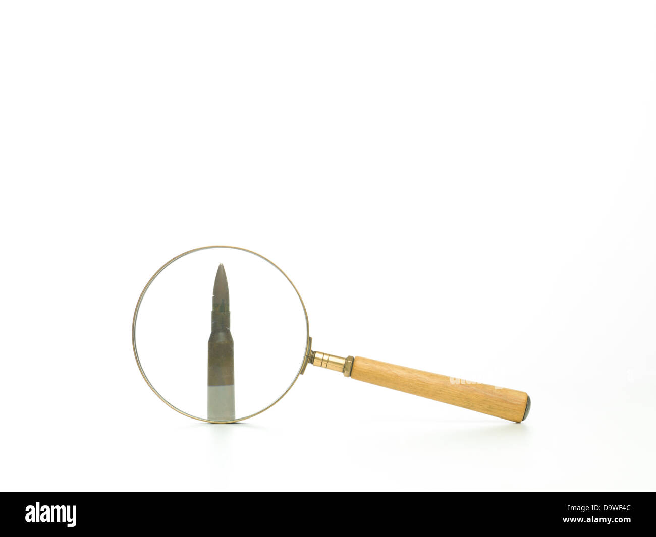 side view of a bullet seen through a magnifying glass, with a white ...
