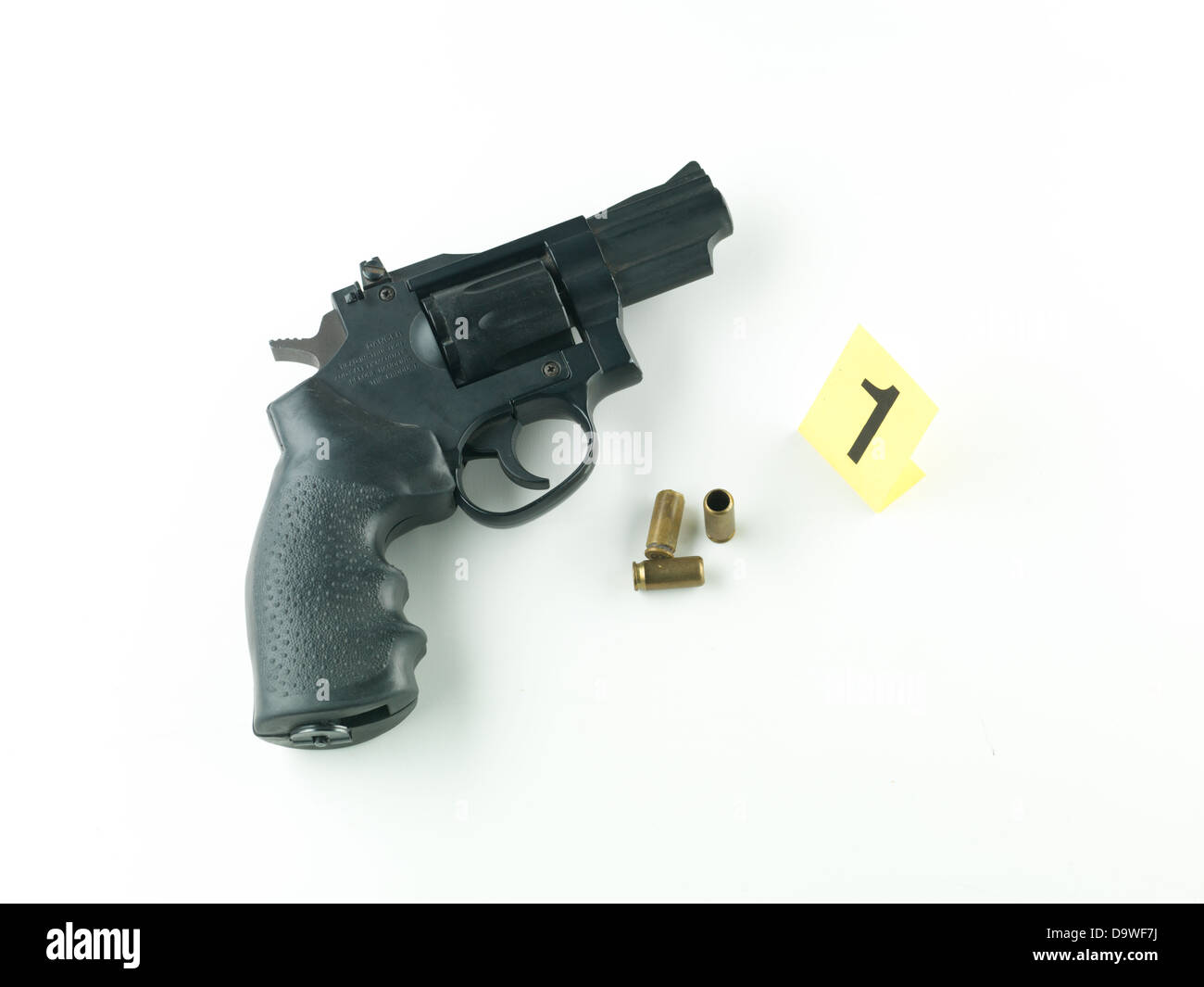 aerial view of a revolver with a bullet and a shell casing and a number ...