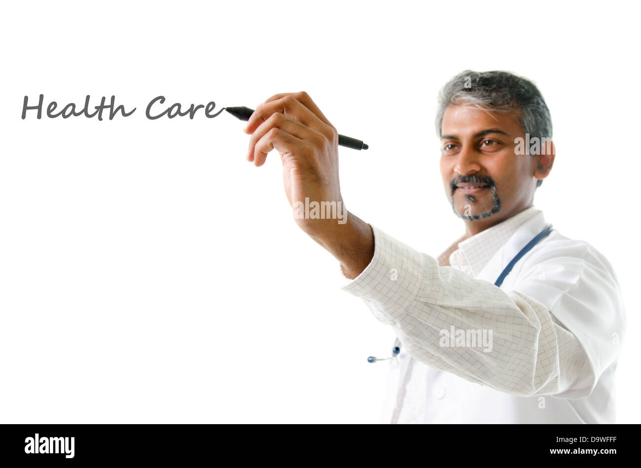 Health care concept. Mature Indian male medical doctor writing on blank ...