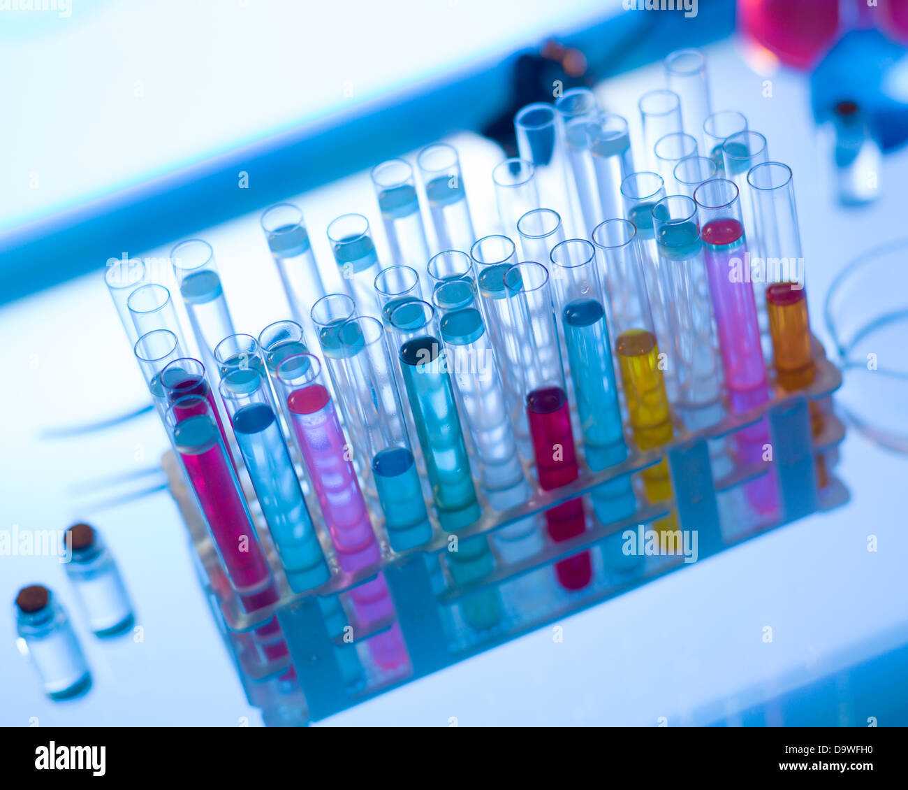 close-up of rack of medical tubes filled with colorful fluids placed on ...