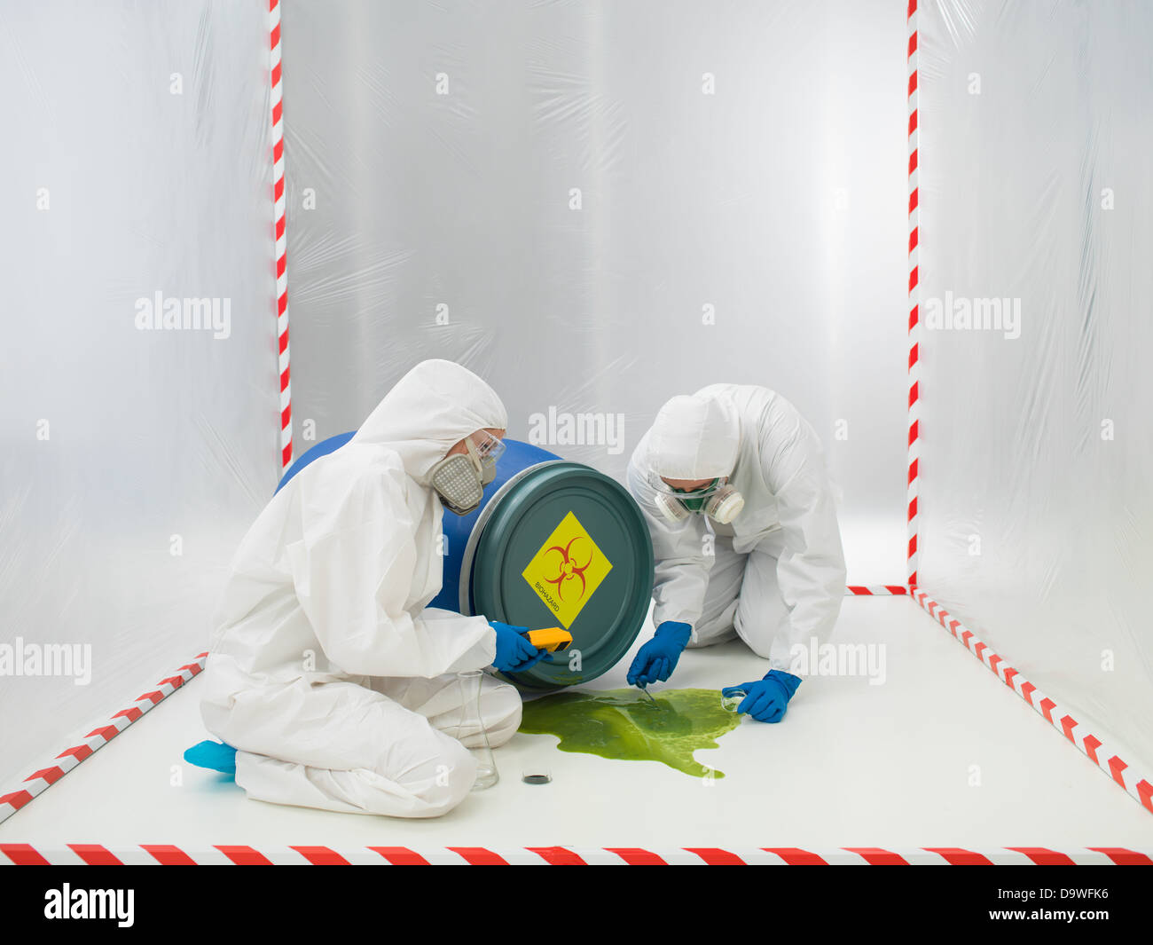 Two laboratory technicians or scientists checking a biohazard that has ...