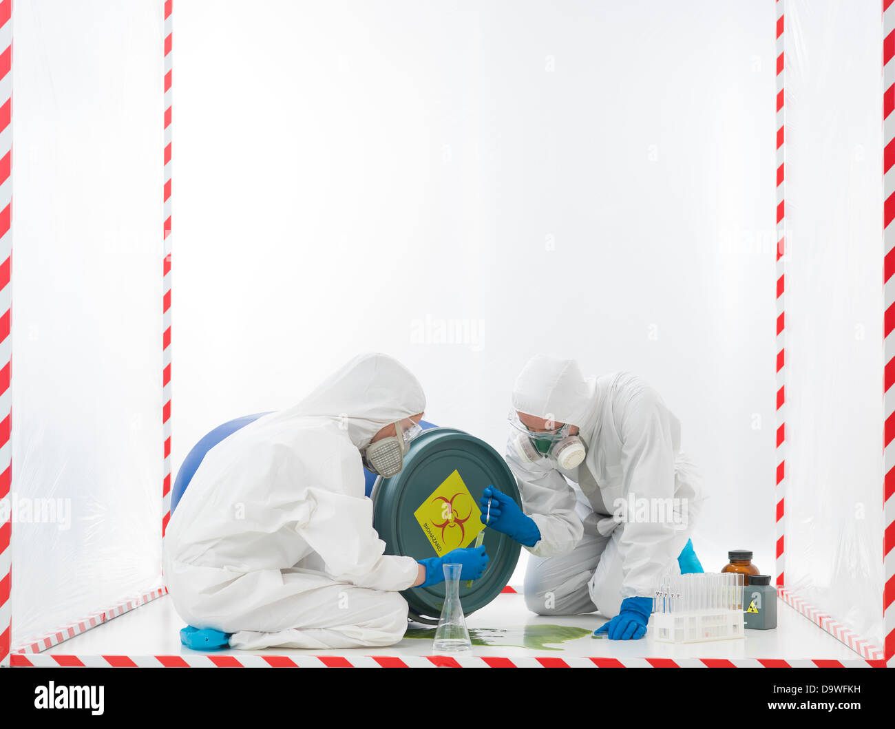 specialists collecting samples from a biohazard accident, in a cube ...
