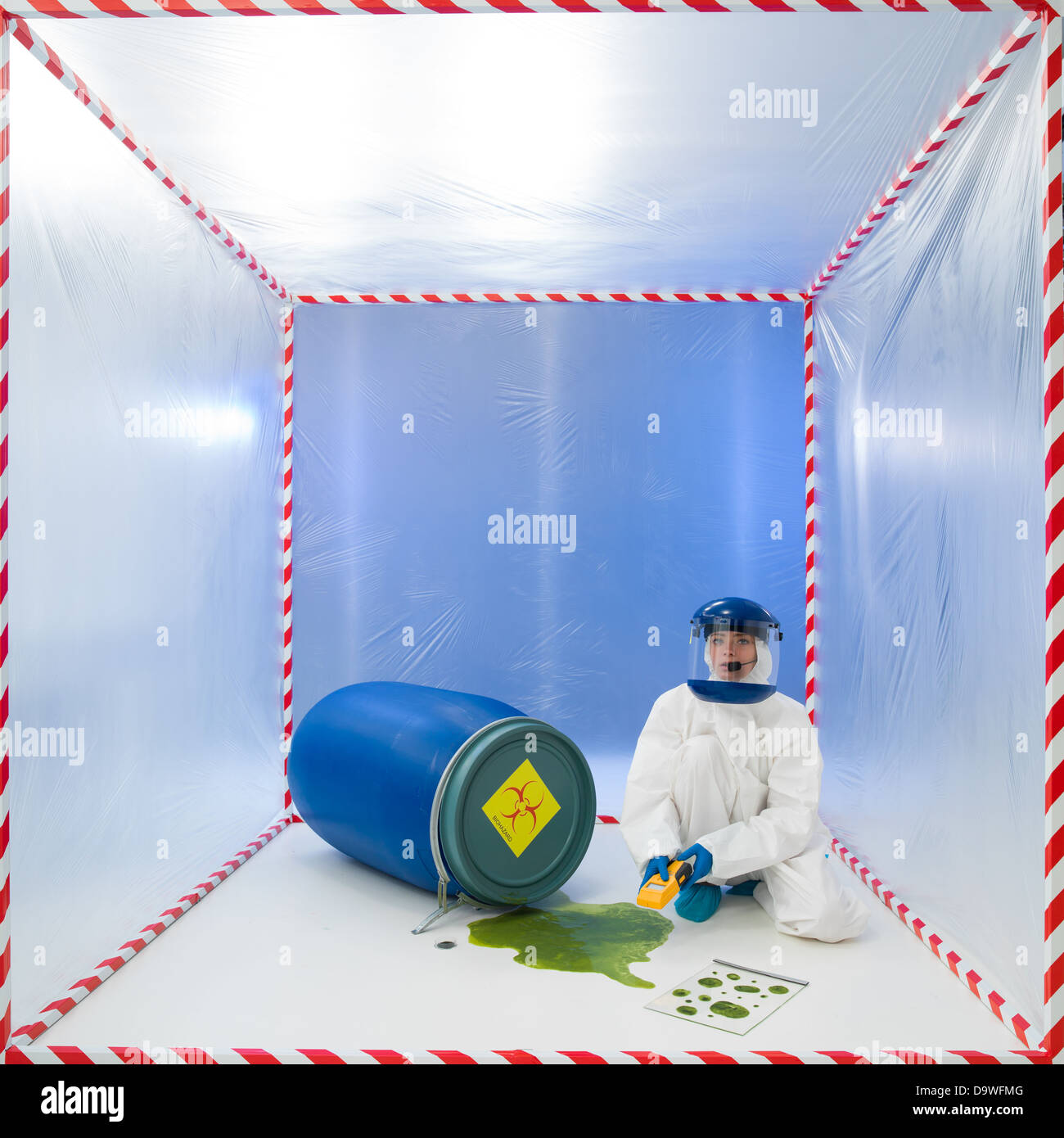 female specialist measuring the level of contamination from a puddle of ...